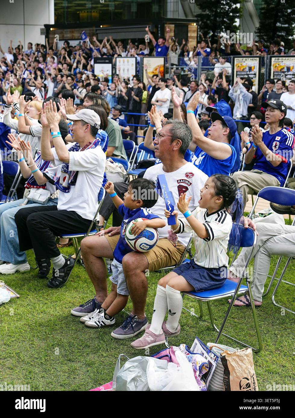 Japan supporters celebrate during a public viewing in Tokyo on June 21 ...