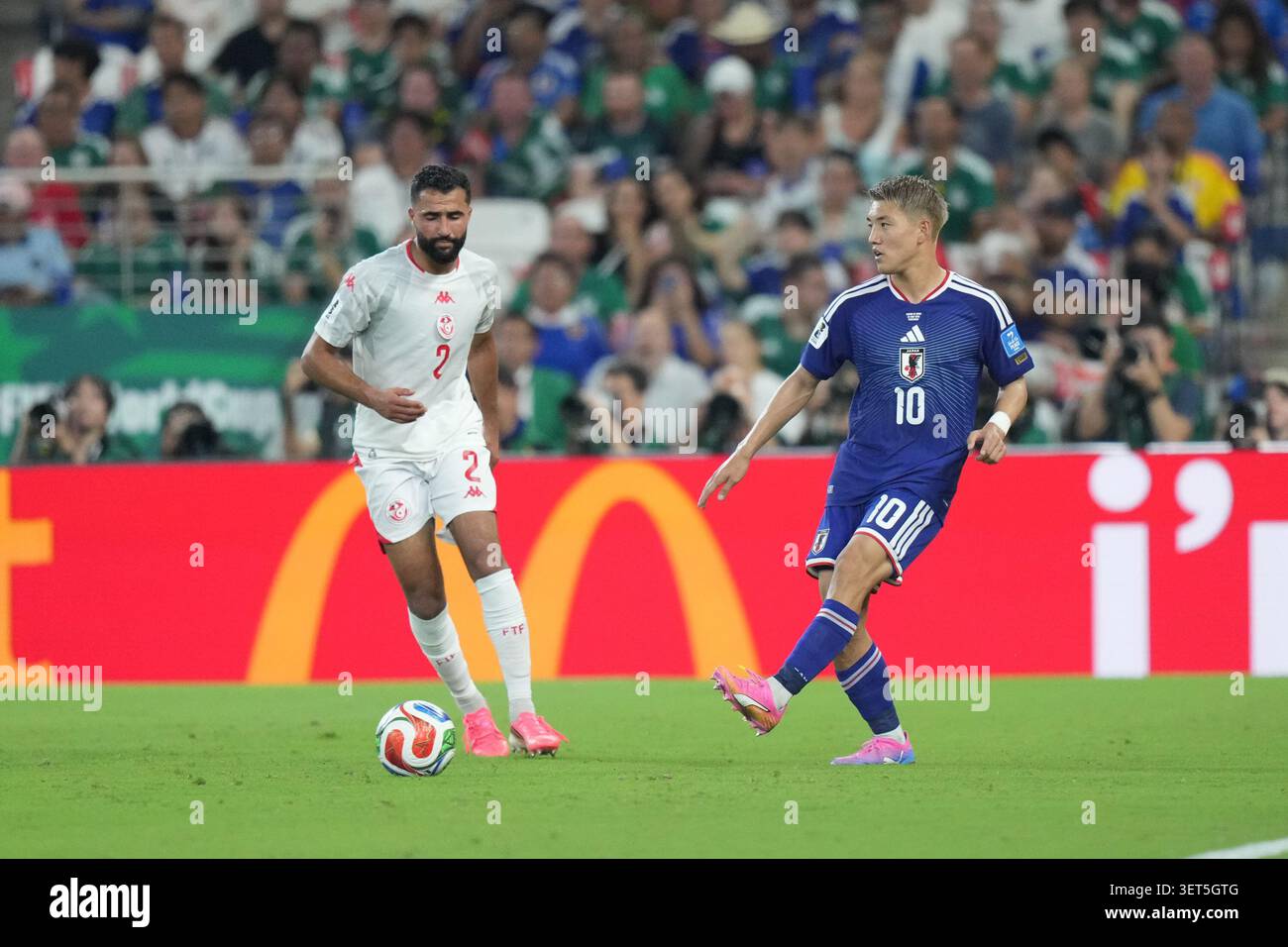 Ali ABDI of Tunisia and Ritsu Doan of Japan during the FIFA World Cup ...