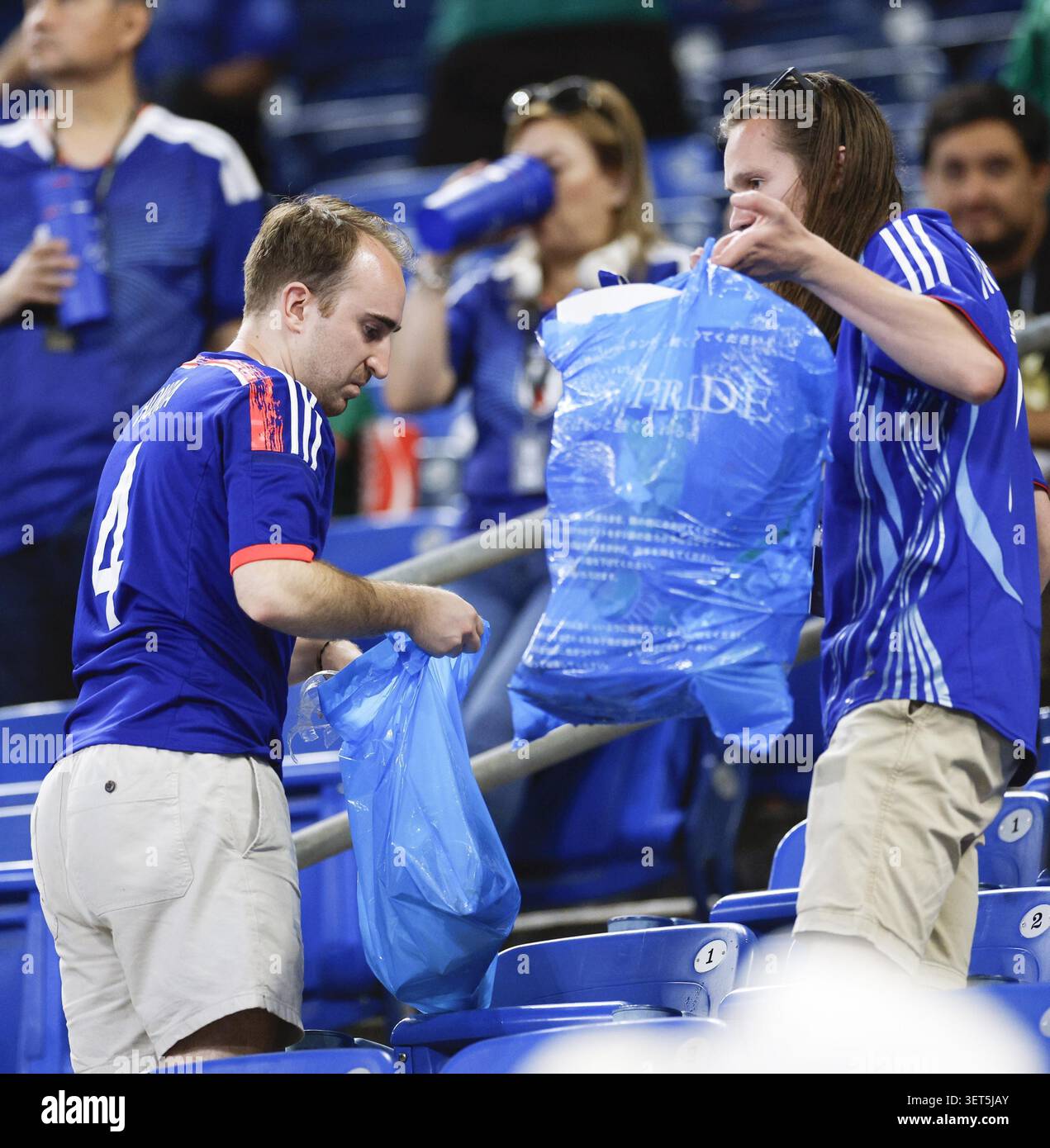 Japan supporters collect trash following Samurai Blue's 4-0 victory in ...