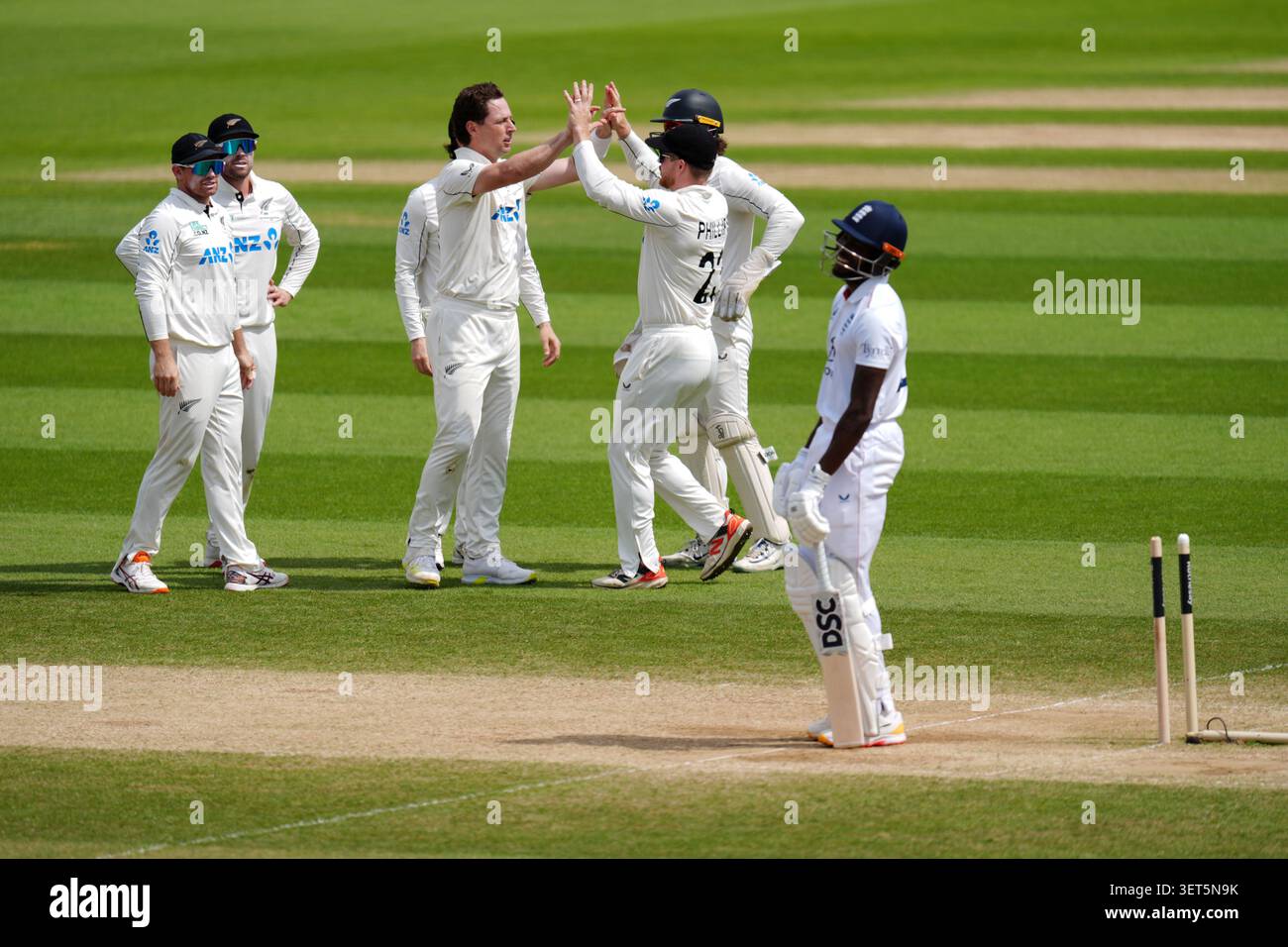 England's Jofra Archer (right) reacts after being bowled out by New ...
