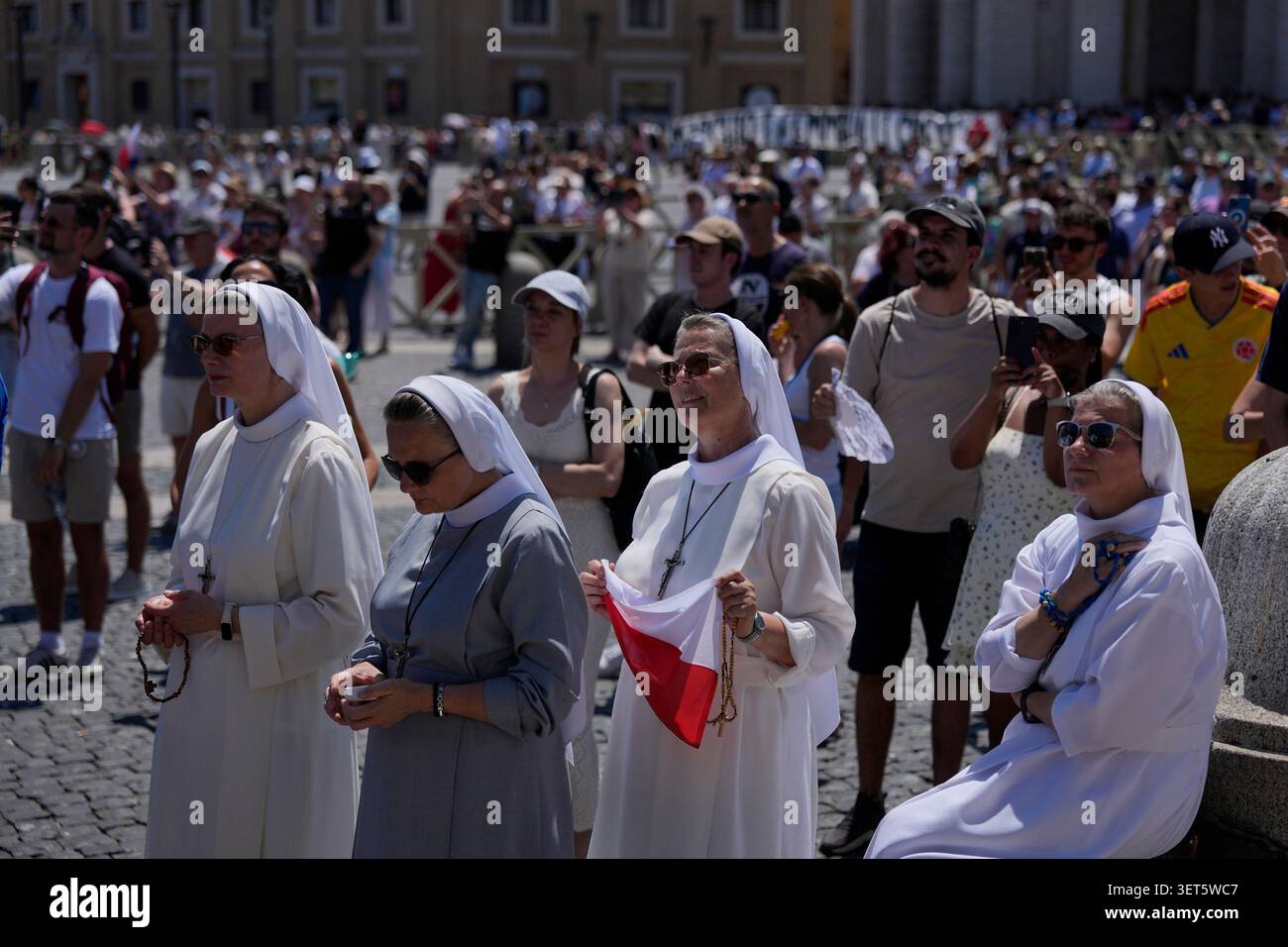 Nuns pray during the Angelus noon prayer led by Pope Leo XIV from the ...