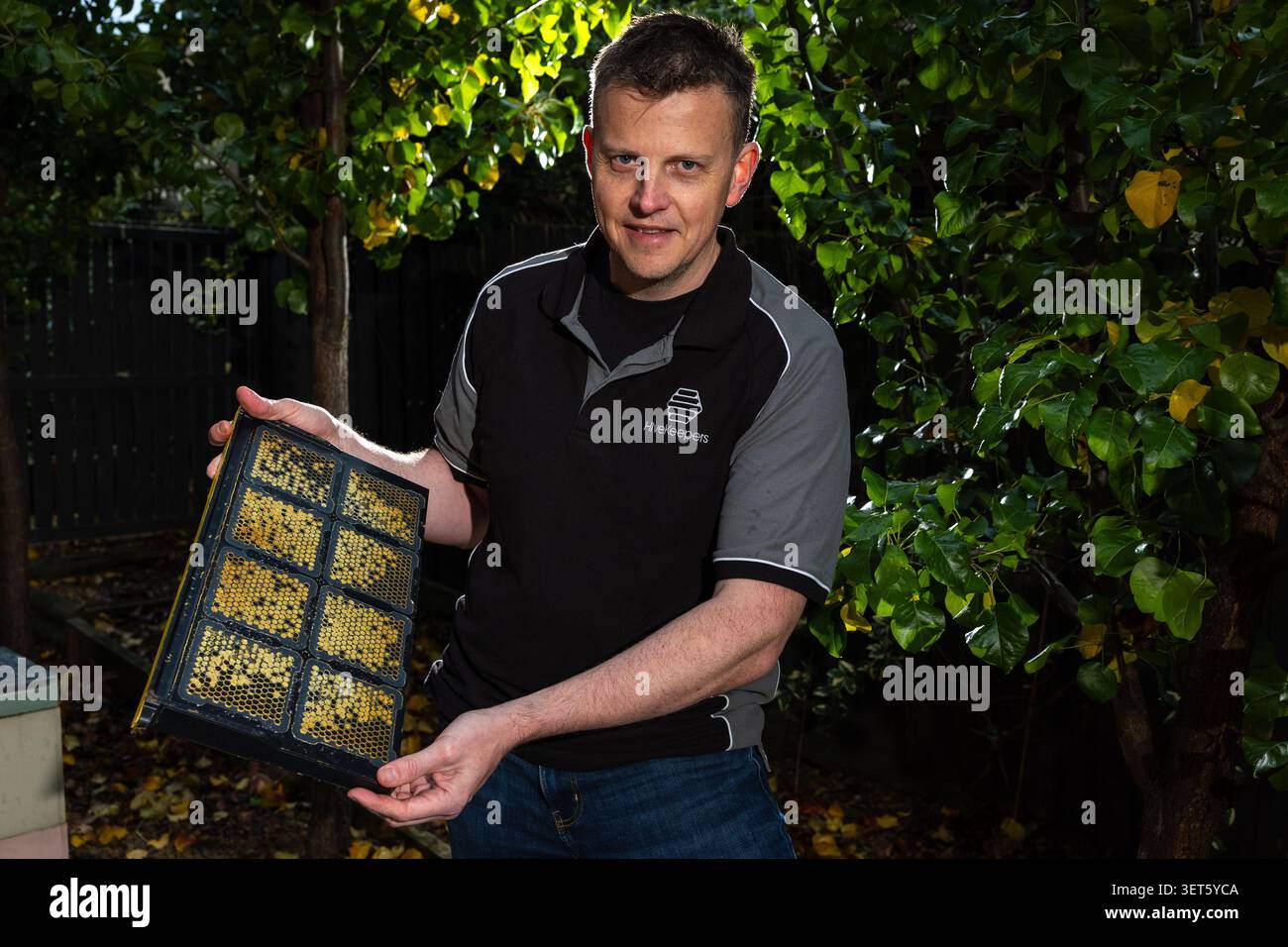 Firefighter turned beekeeper Simon Mildren poses for a photo in ...