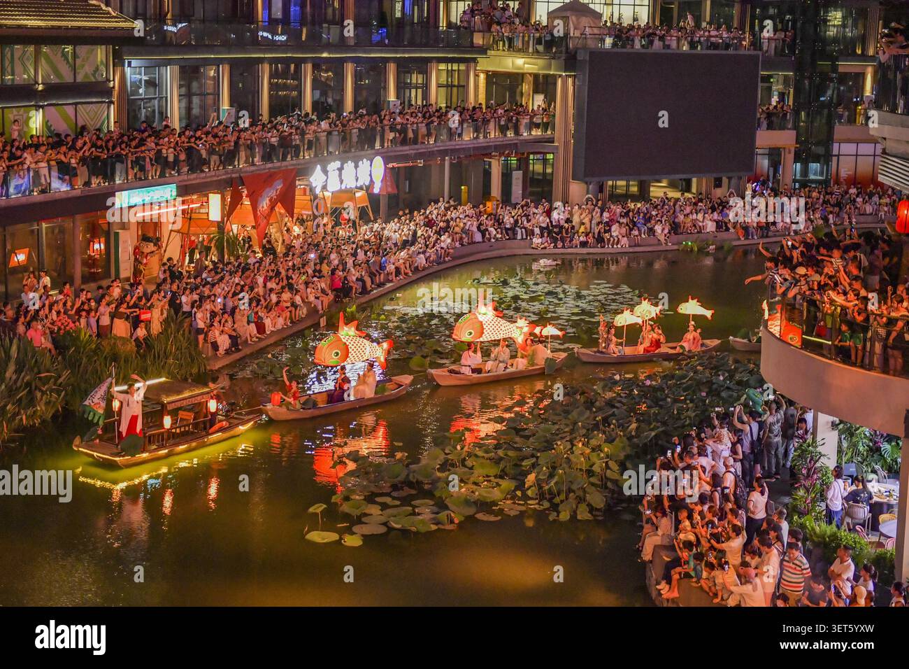 People watch a 100-meter fish lantern parade in traditional Han ...