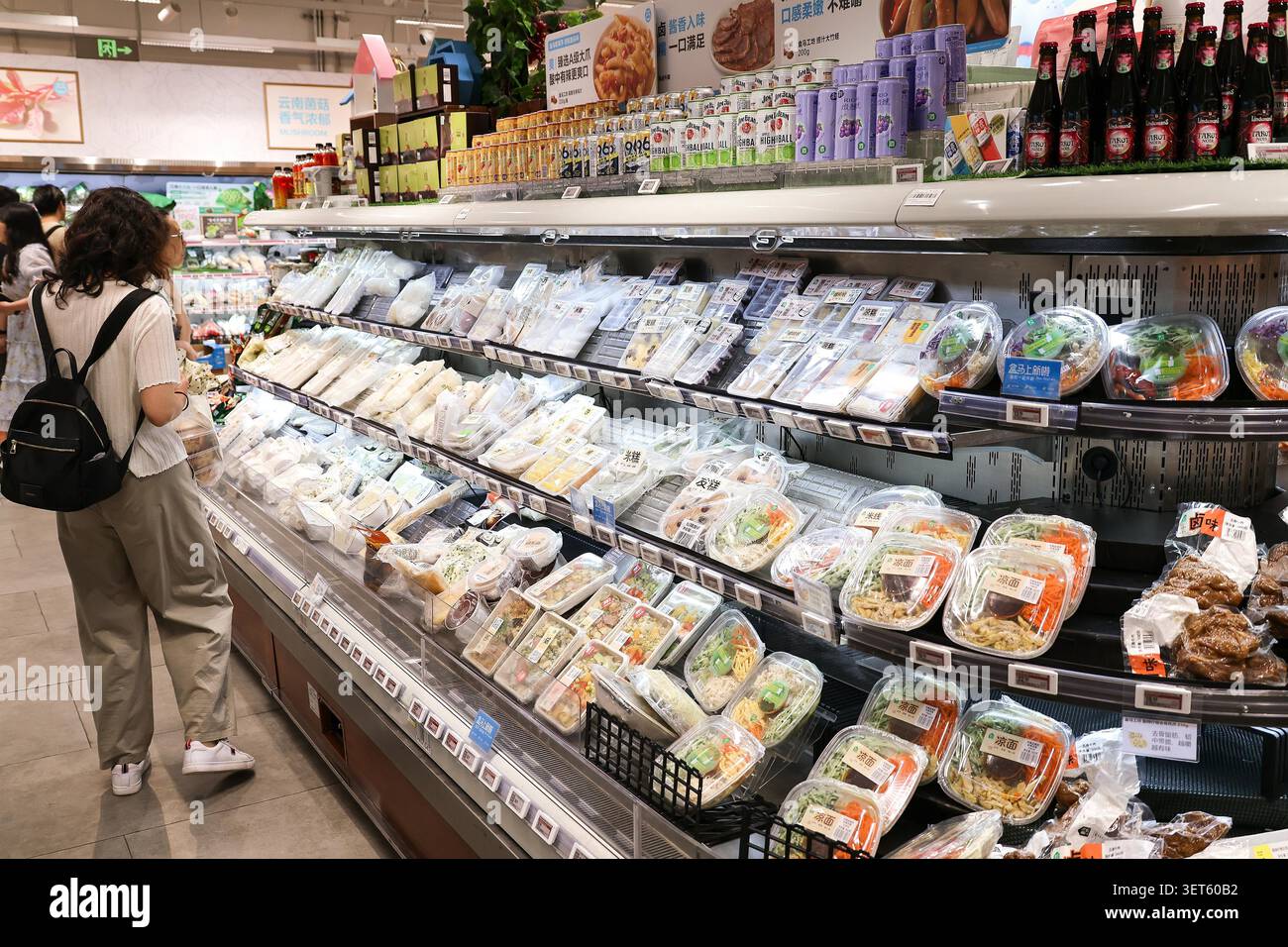 Shoppers select semi-prepared food at a Hema supermarket in Shanghai ...