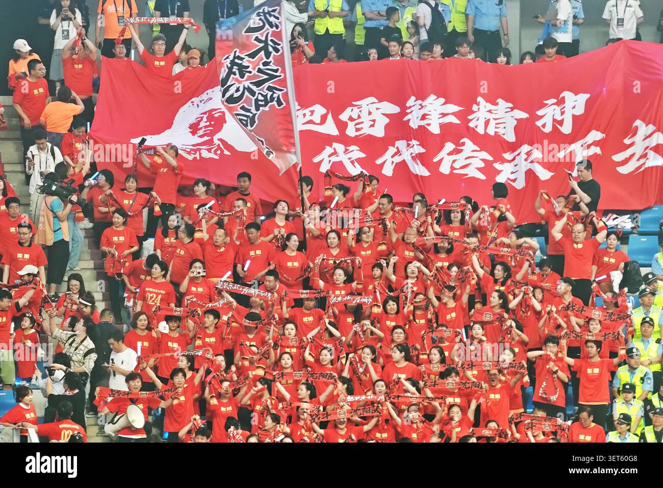 Football fans watch a match at Dalian Suoyuwan Football Stadium in ...