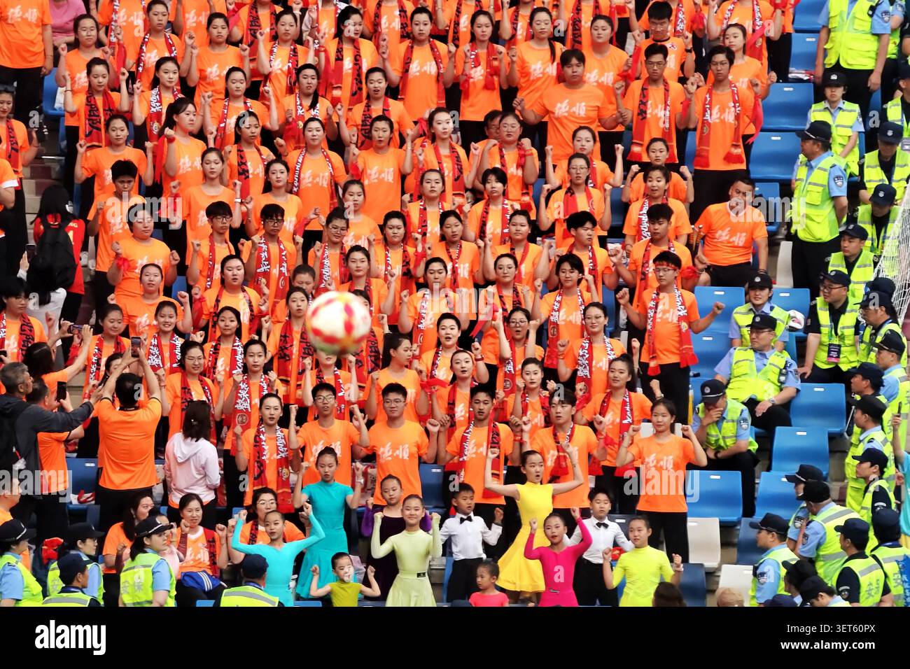 Football fans watch a match at Dalian Suoyuwan Football Stadium in ...