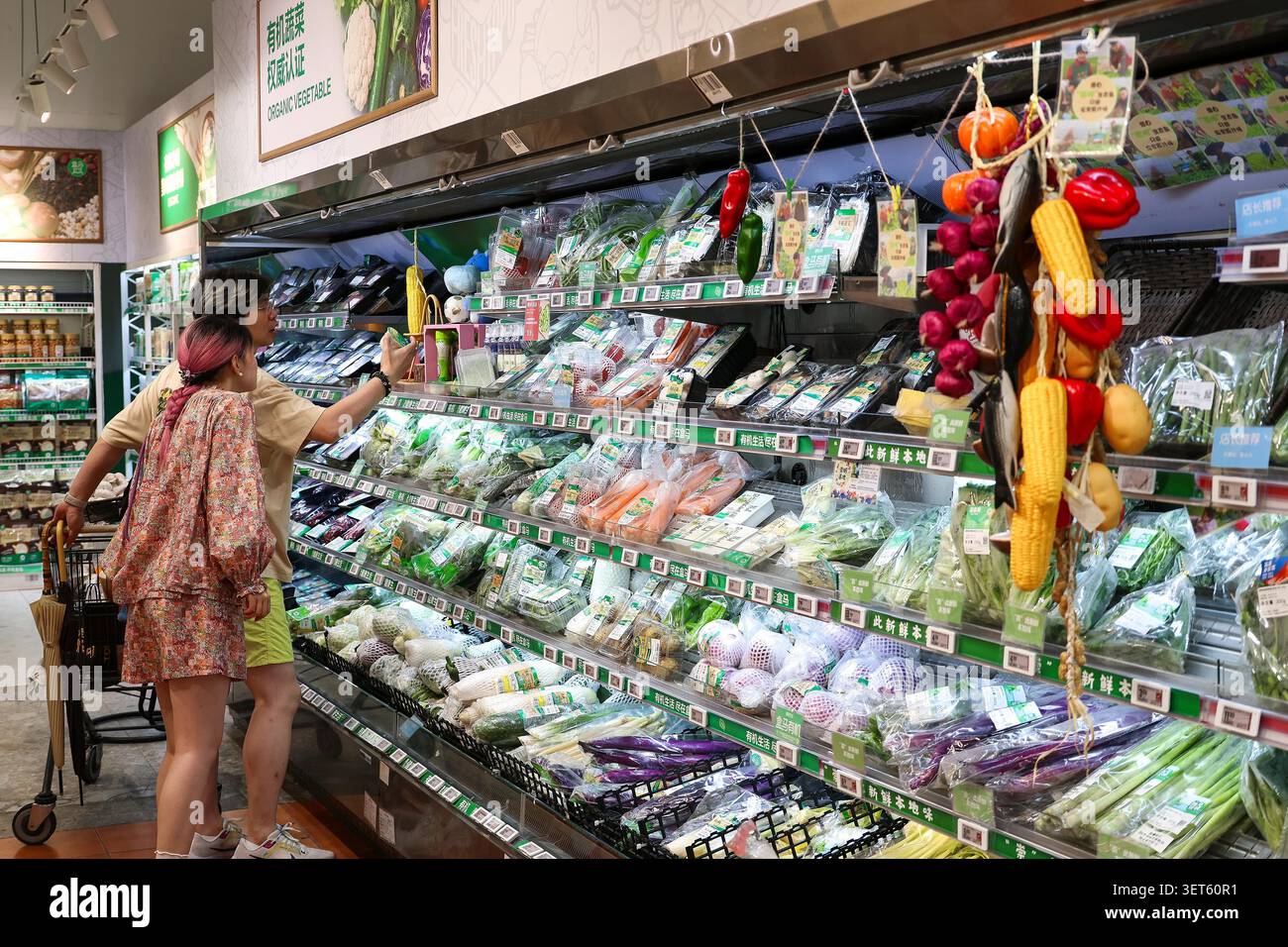 Customers select vegetables and fruits at Hema supermarket in Shanghai ...