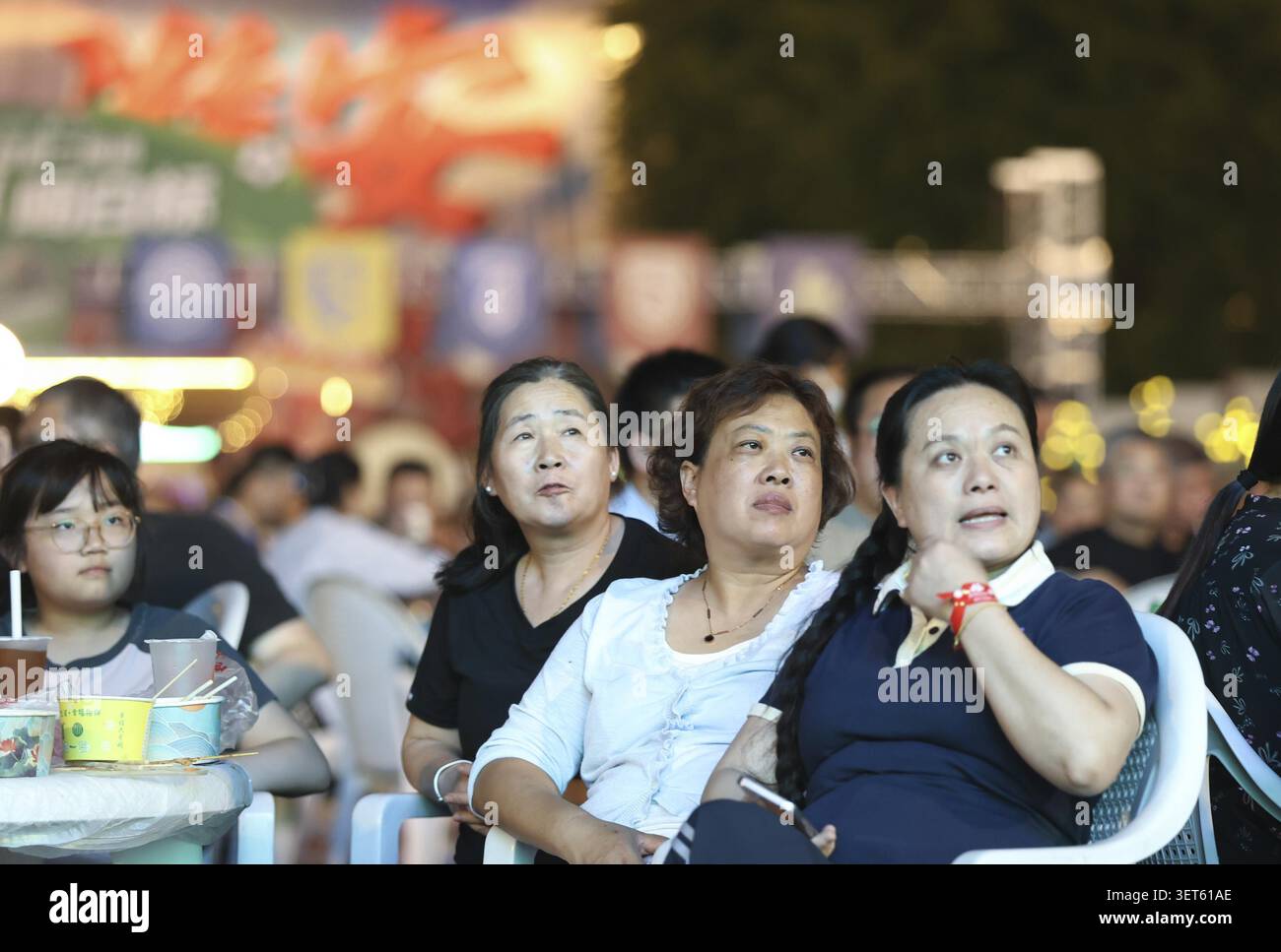 Fans enjoy food while watching the 'Su Super League' match at ...