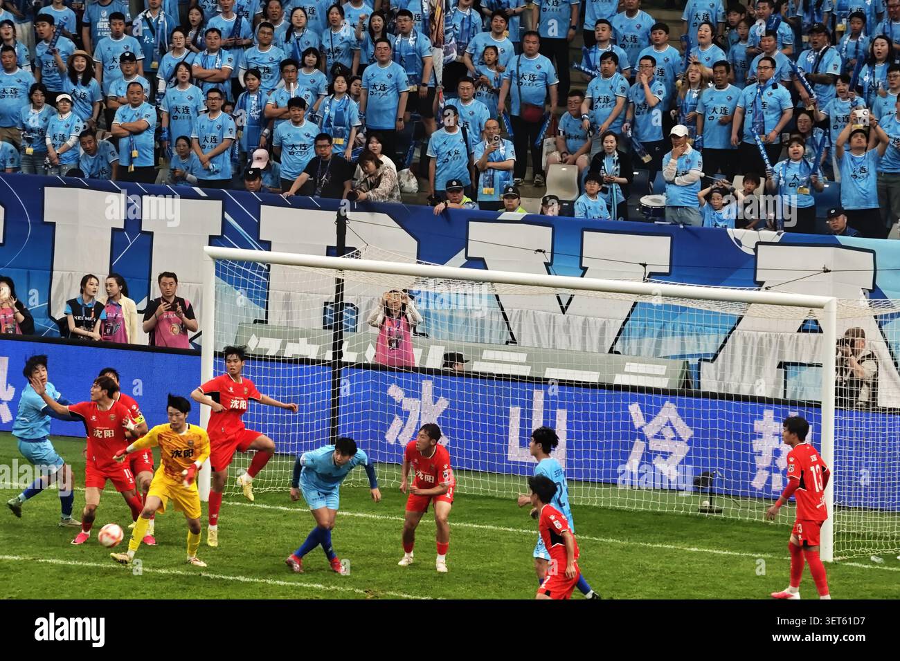Football fans watch a match at Dalian Suoyuwan Football Stadium in ...
