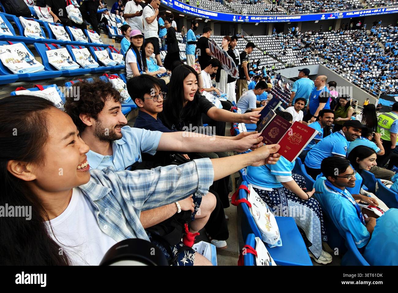 Football fans watch a match at Dalian Suoyuwan Football Stadium in ...
