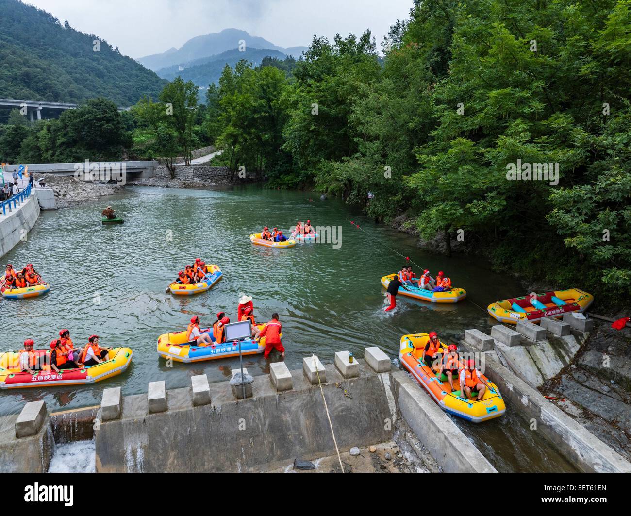 Tourists enjoy drifting at Wudao Gorge Drift Scenic Area in Baokang ...