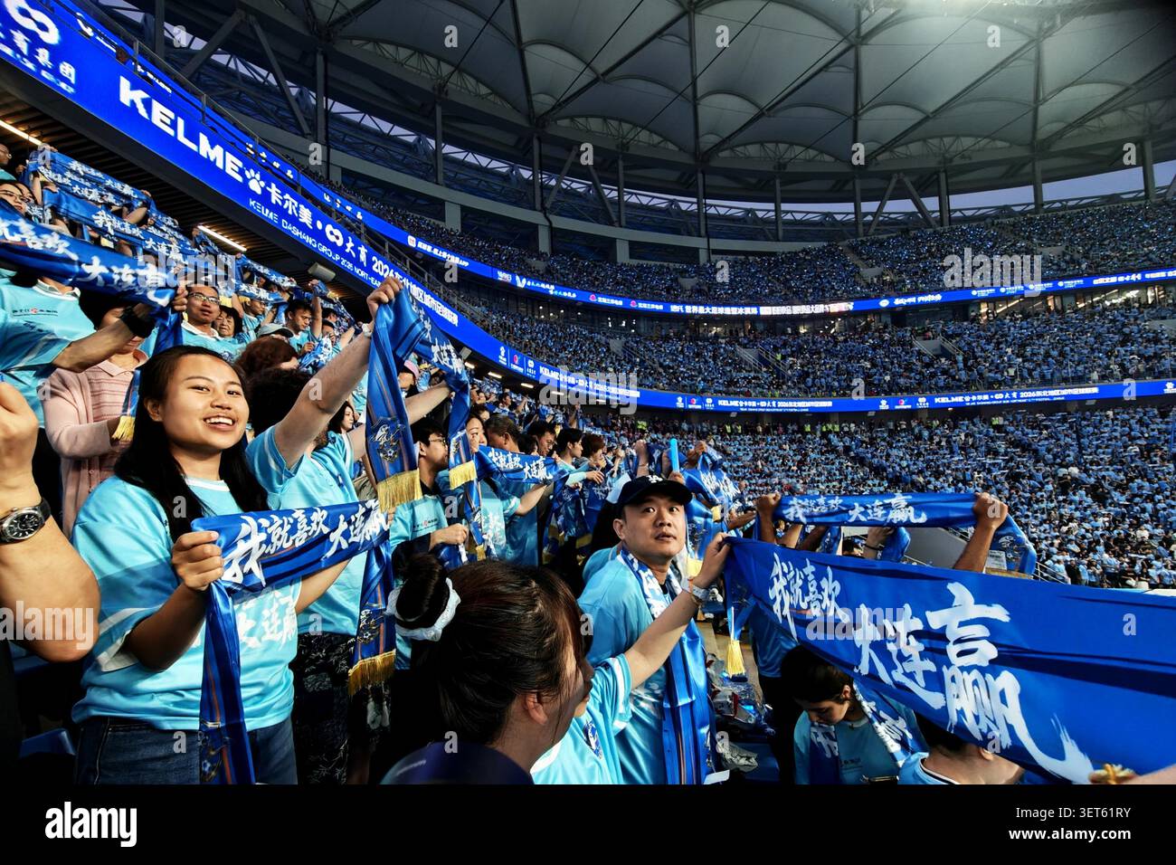 Football fans watch a match at Dalian Suoyuwan Football Stadium in ...