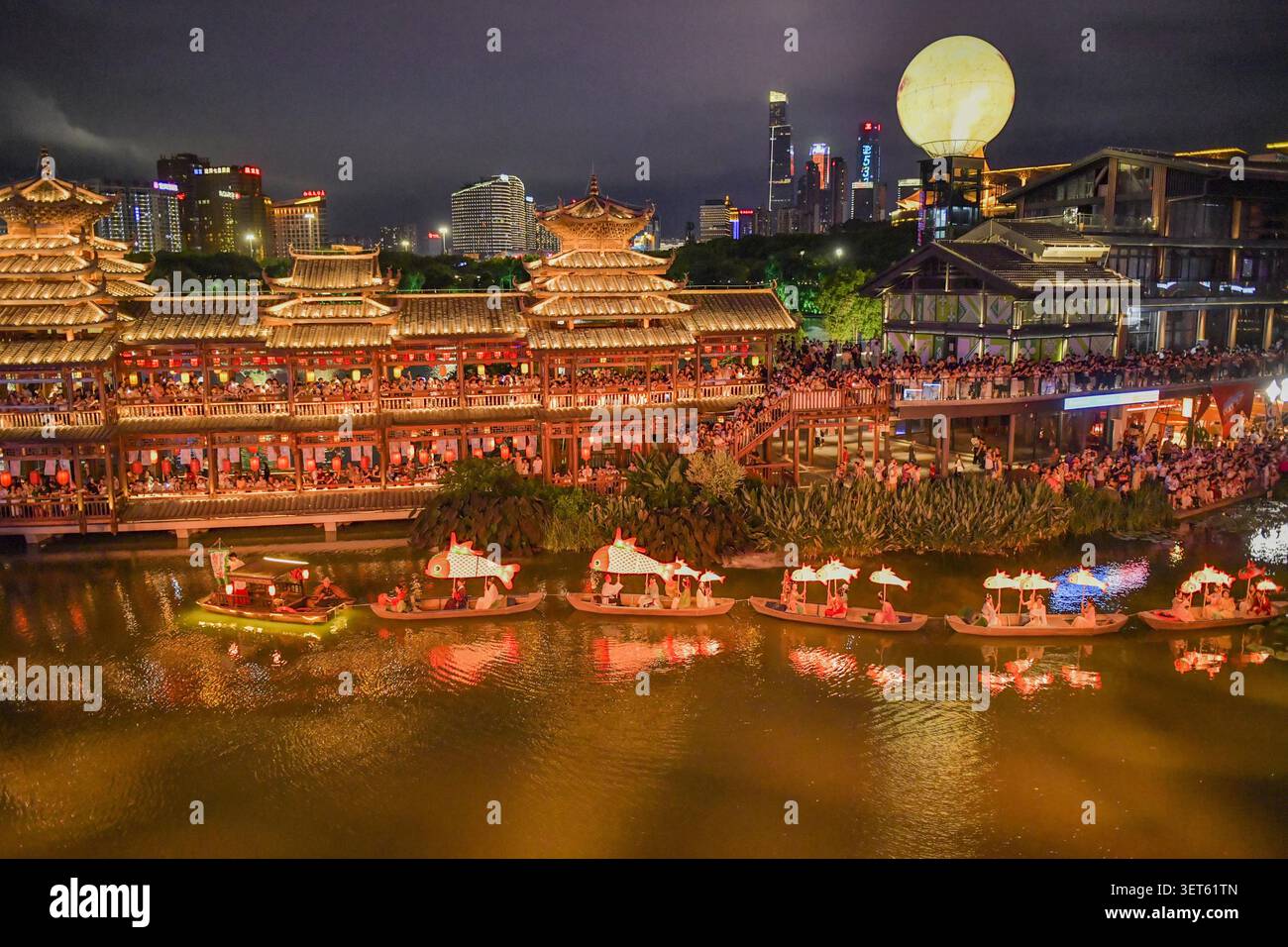 People watch a 100-meter fish lantern parade in traditional Han ...