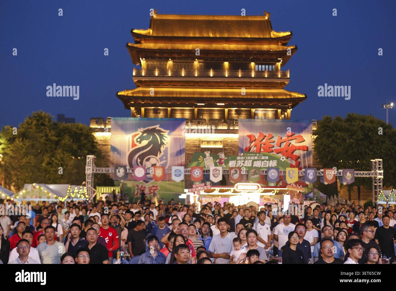 Fans enjoy food while watching the 'Su Super League' match at ...
