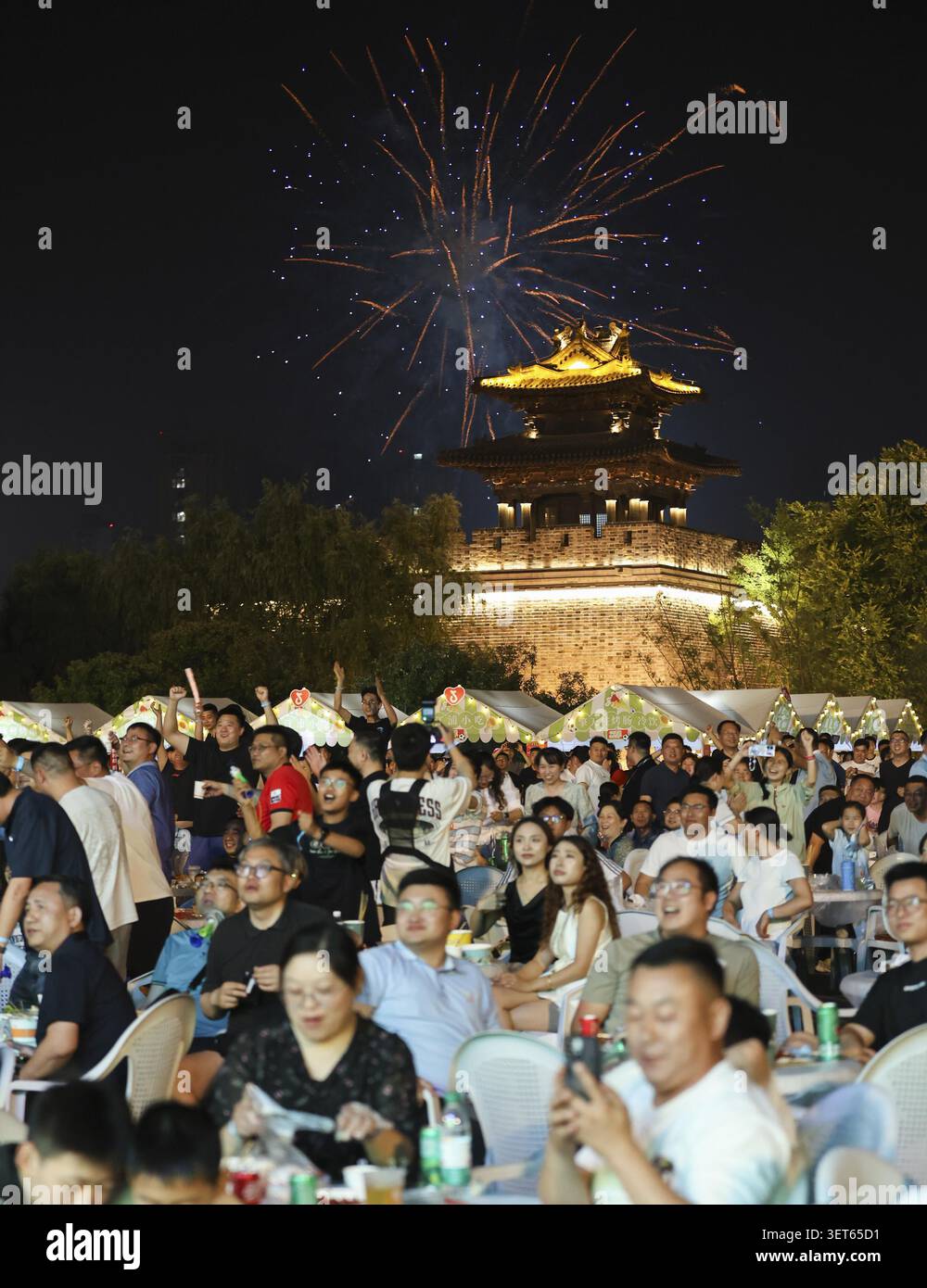 Fans enjoy food while watching the 'Su Super League' match at ...