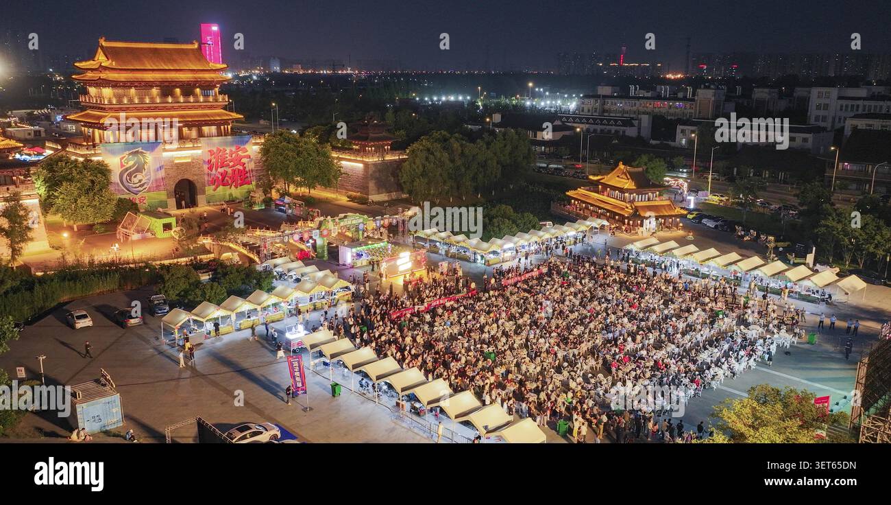 Fans enjoy food while watching the 'Su Super League' match at ...