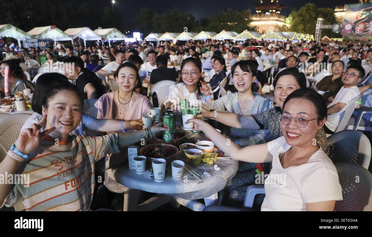 Fans enjoy food while watching the 'Su Super League' match at ...