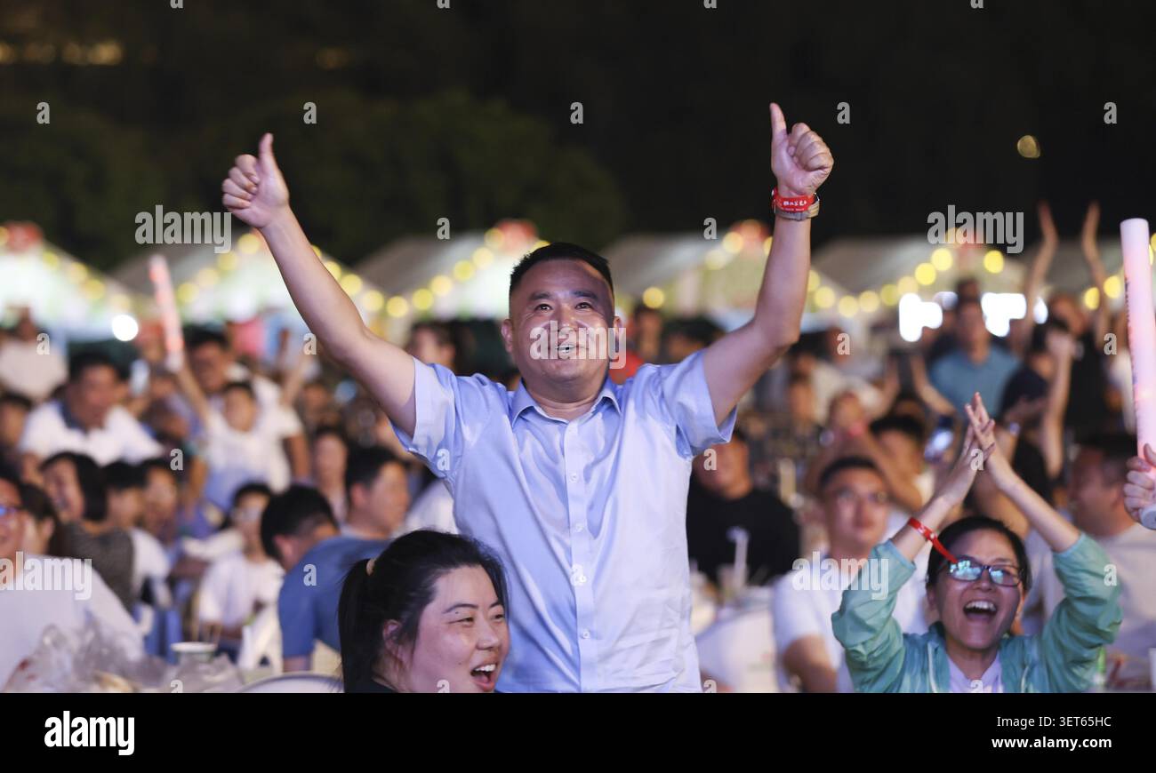 Fans enjoy food while watching the 'Su Super League' match at ...
