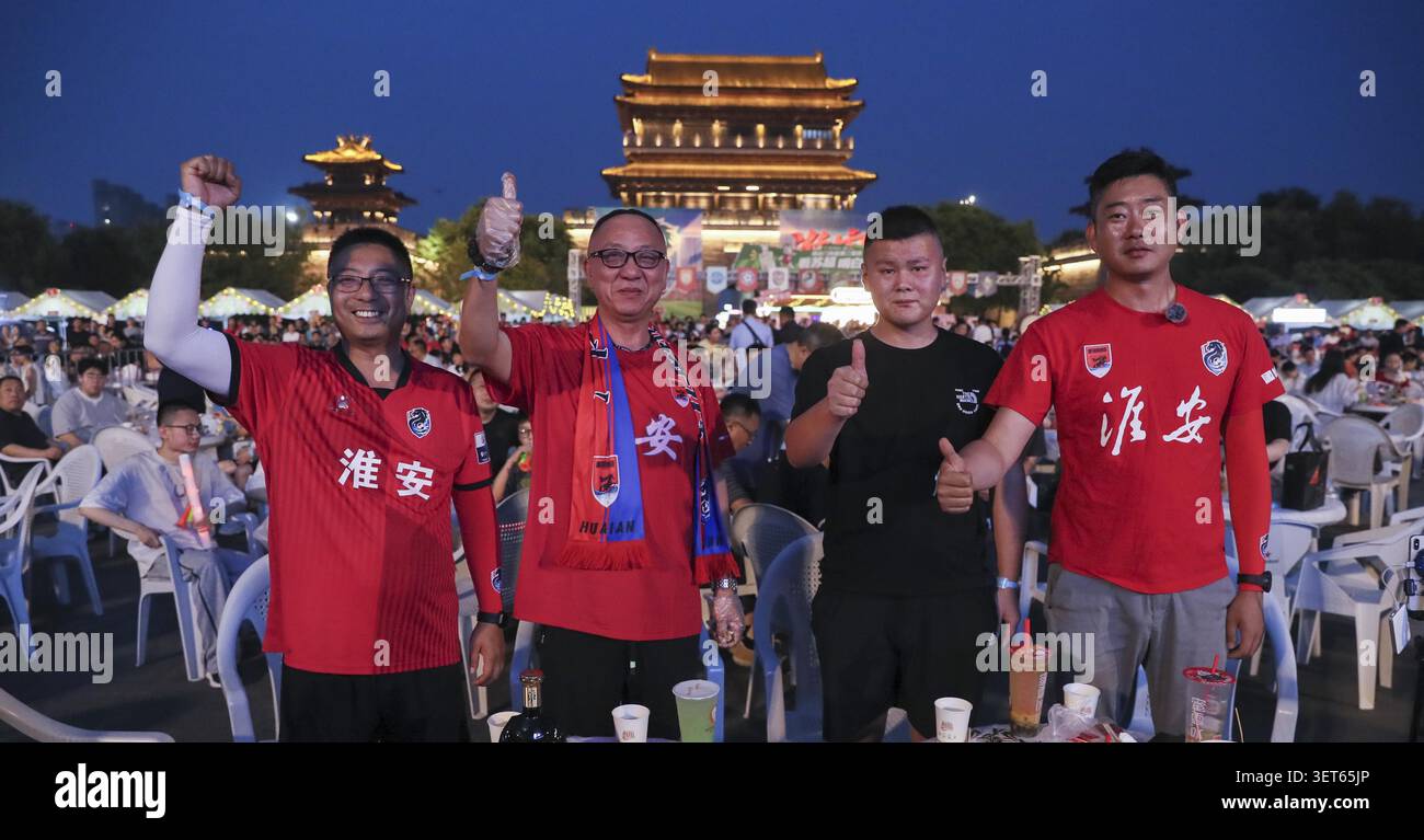 Fans enjoy food while watching the 'Su Super League' match at ...