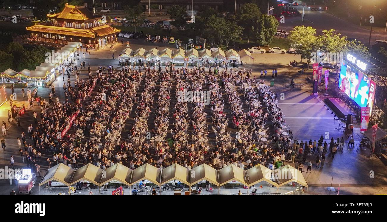 Fans enjoy food while watching the 'Su Super League' match at ...
