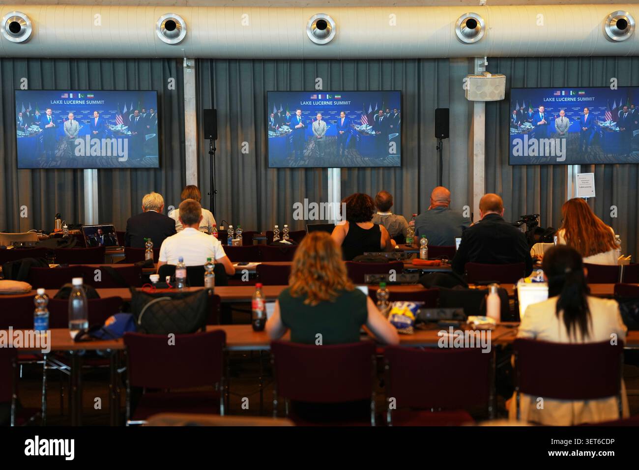 Members of the media watch screens broadcasting the Iran US ...