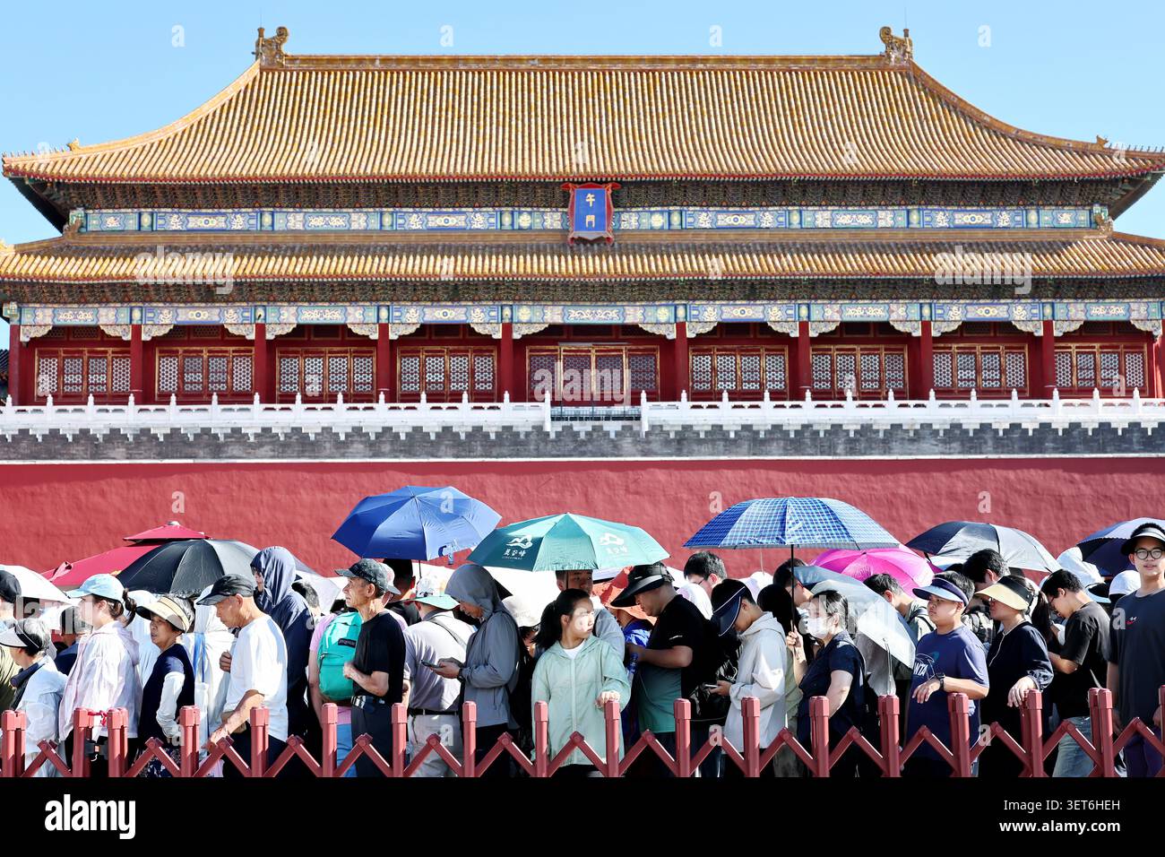 Tourists use various sun protection methods at the Forbidden City in ...
