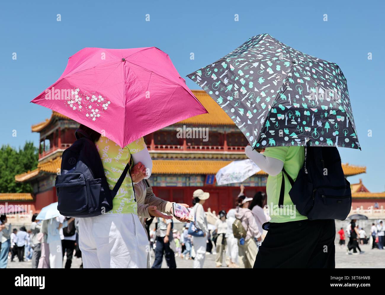 Tourists use various sun protection methods at the Forbidden City in ...