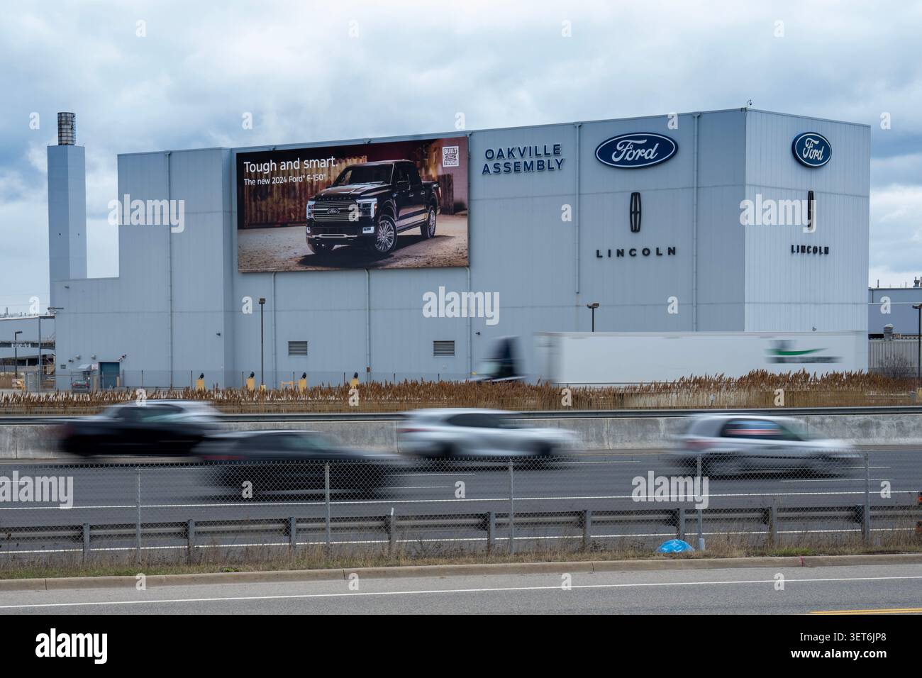 Cars zoom past the Ford Oakville Assembly plant in Oakville, Ont. on ...