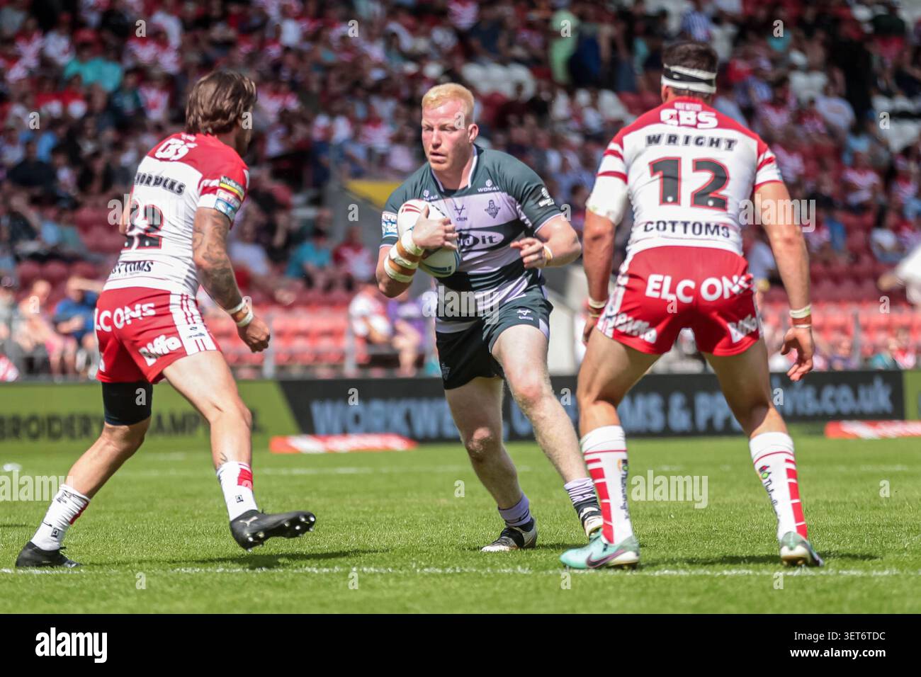 Matty English runs a the St Helens defence during the BetFred Super ...