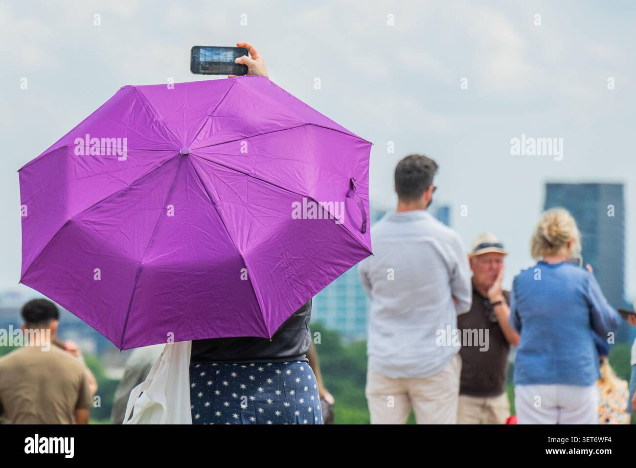 Some strip off to sunbathe others use umbrellas as parasols to provide ...