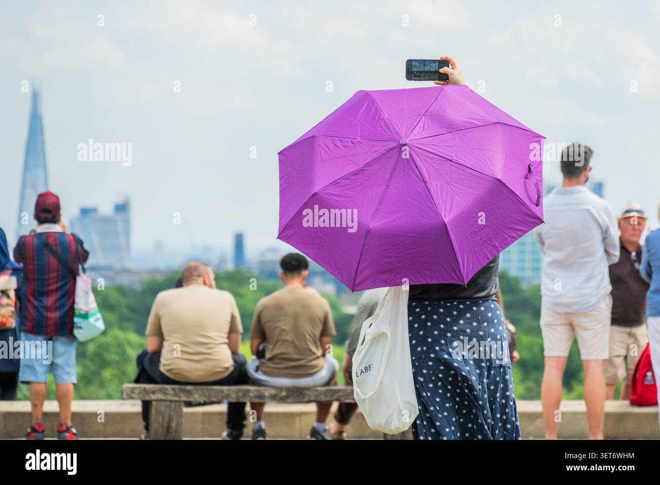 Some strip off to sunbathe others use umbrellas as parasols to provide ...