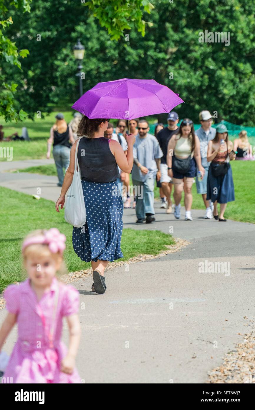 Some strip off to sunbathe others use umbrellas as parasols to provide ...