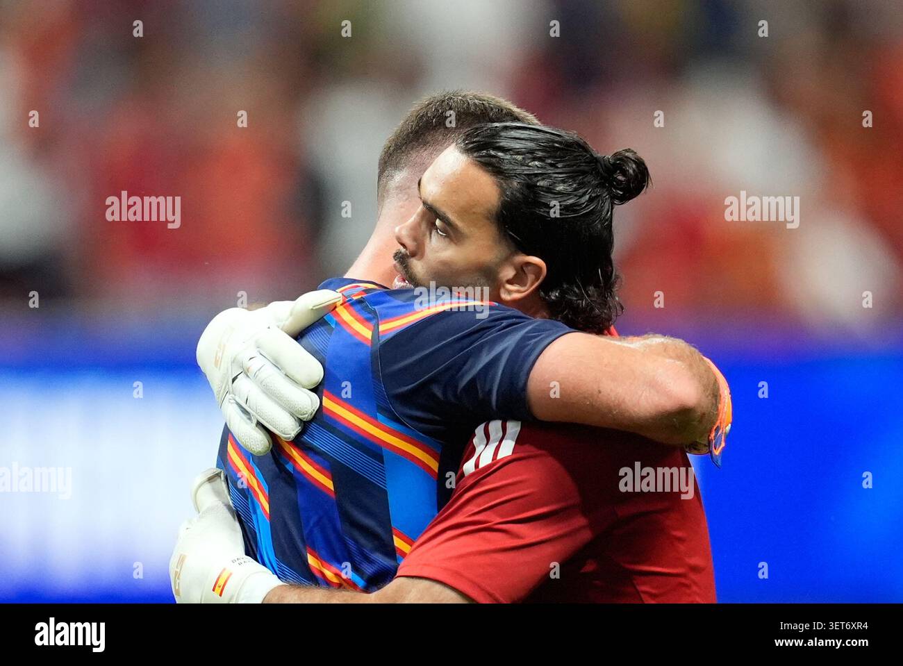 Spain goalkeepers David Raya, right, and goalkeeper Unai Simon hug each ...