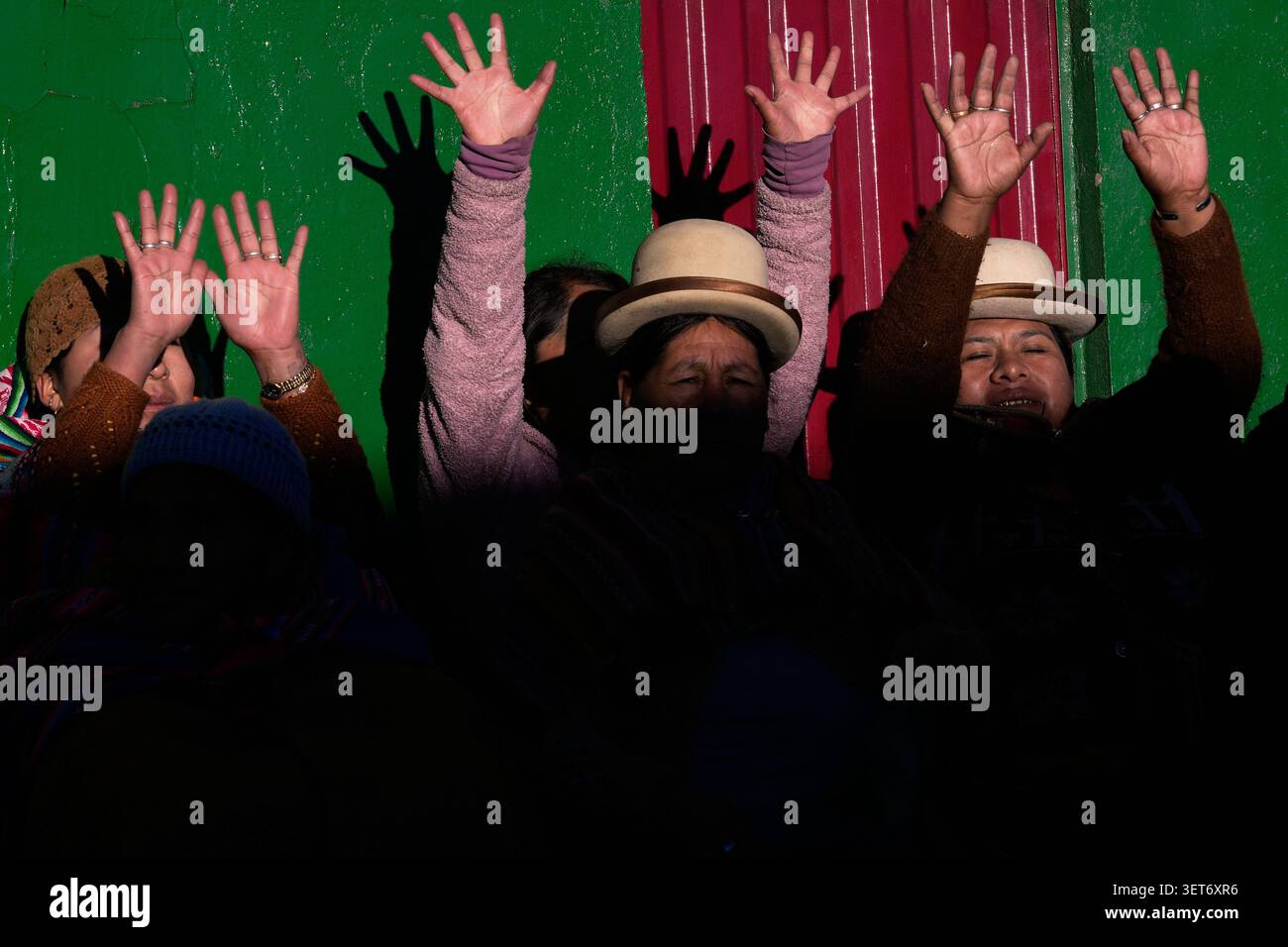 Aymara Indigenous people raise their hands to receive the first rays of ...