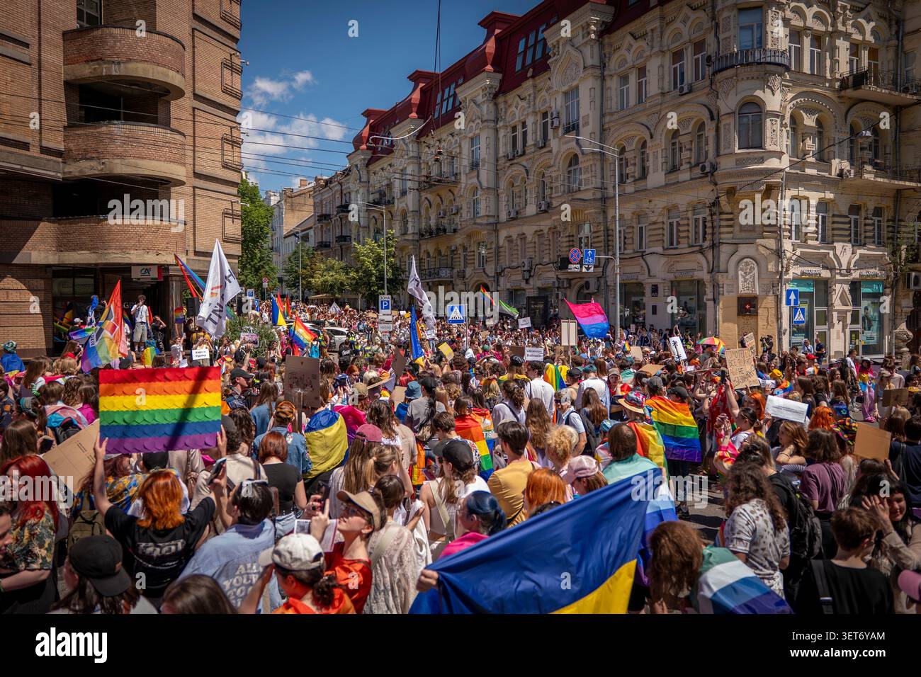 Demonstrators are waving rainbow and Ukrainian flags, filling the main ...