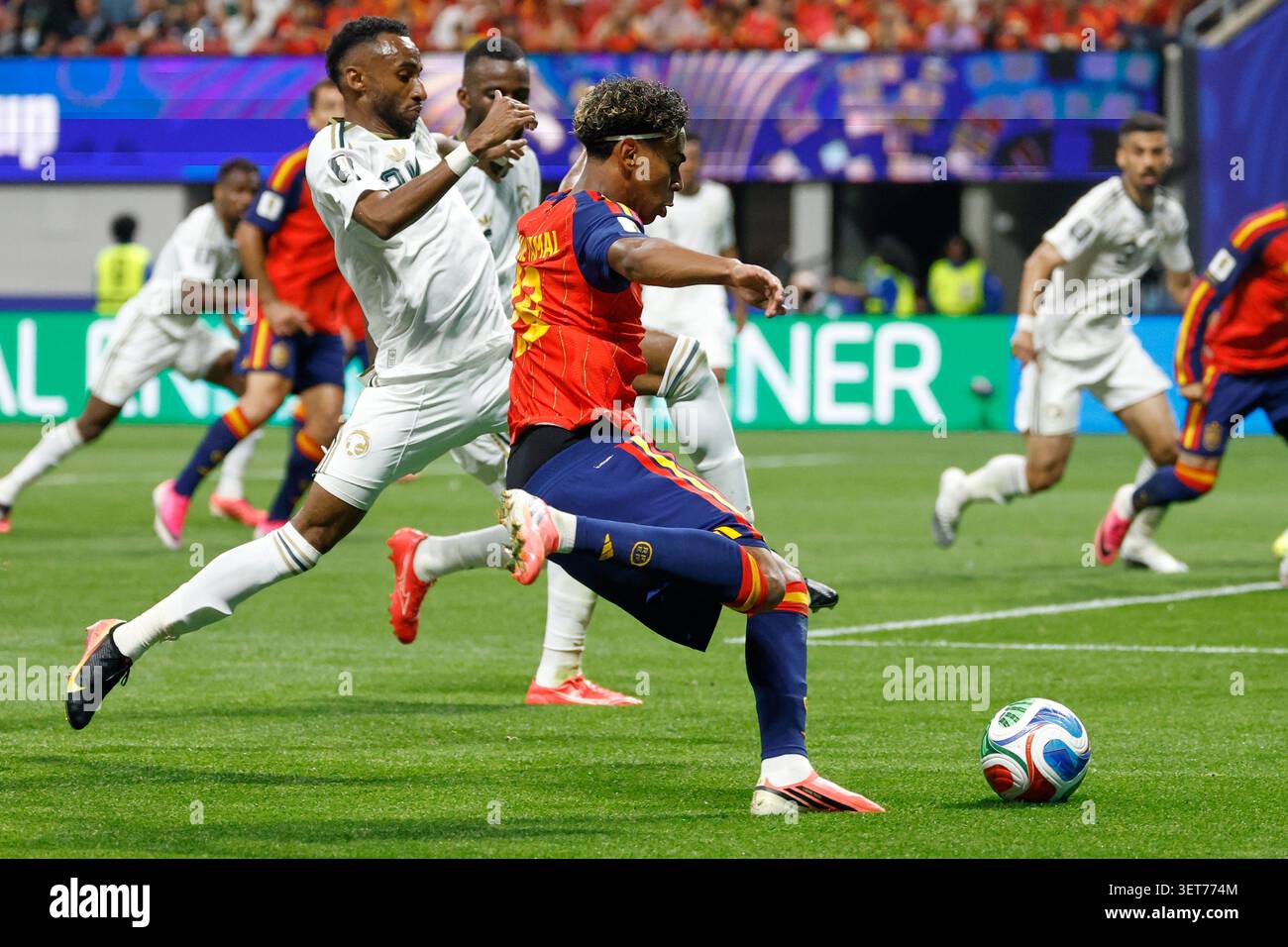 Spain's Lamine Yamal kicks the ball as Saudi Arabia's Moteb Alharbi ...