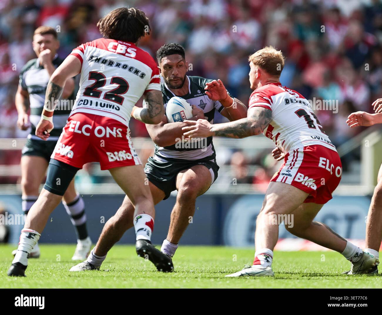 Taane Milne runs at the St Helens defence during the BetFred Super ...