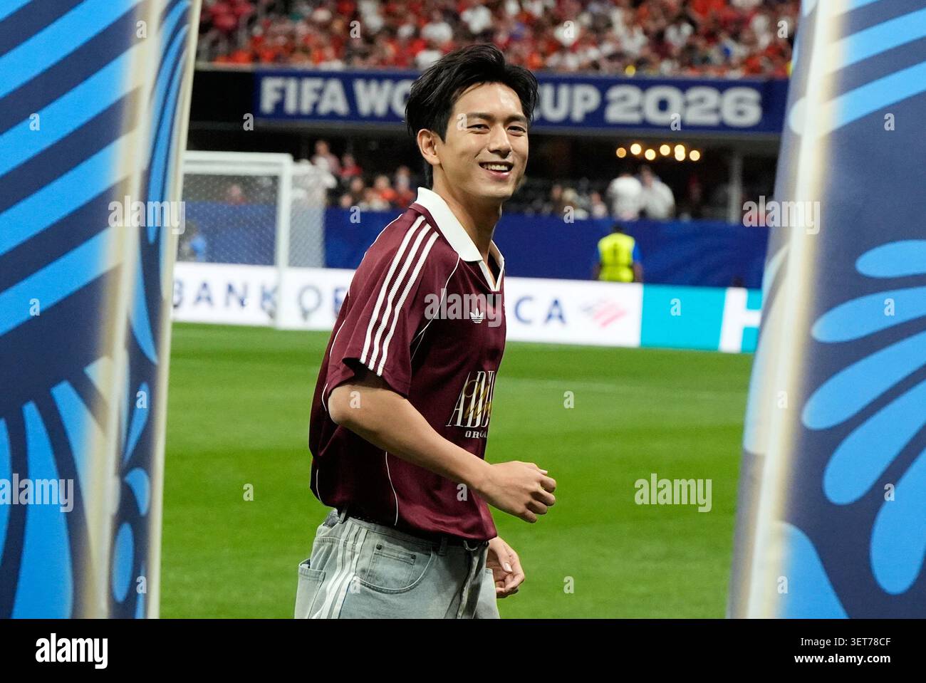 Chinese actor Li Xian walks on the pitch ahead of the World Cup Group H ...