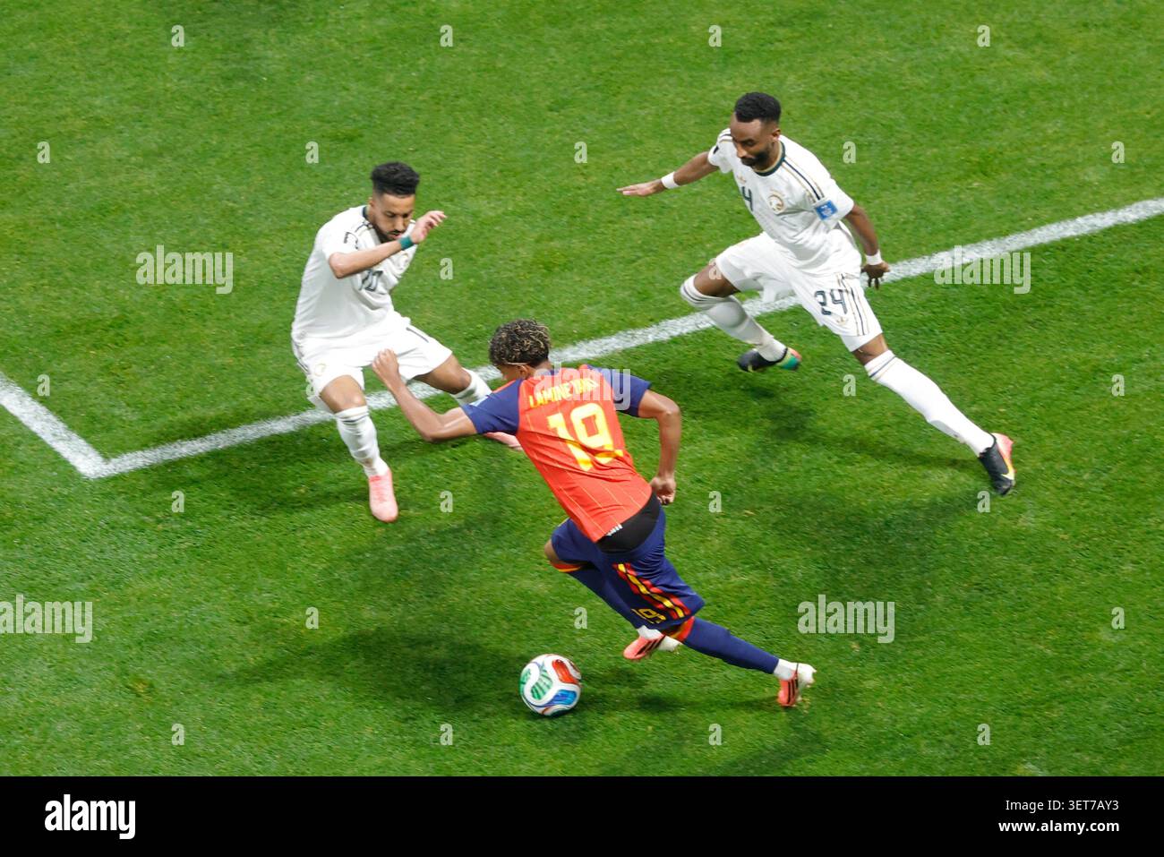 Spain's Lamine Yamal, bottom, controls the ball challenged by Saudi ...