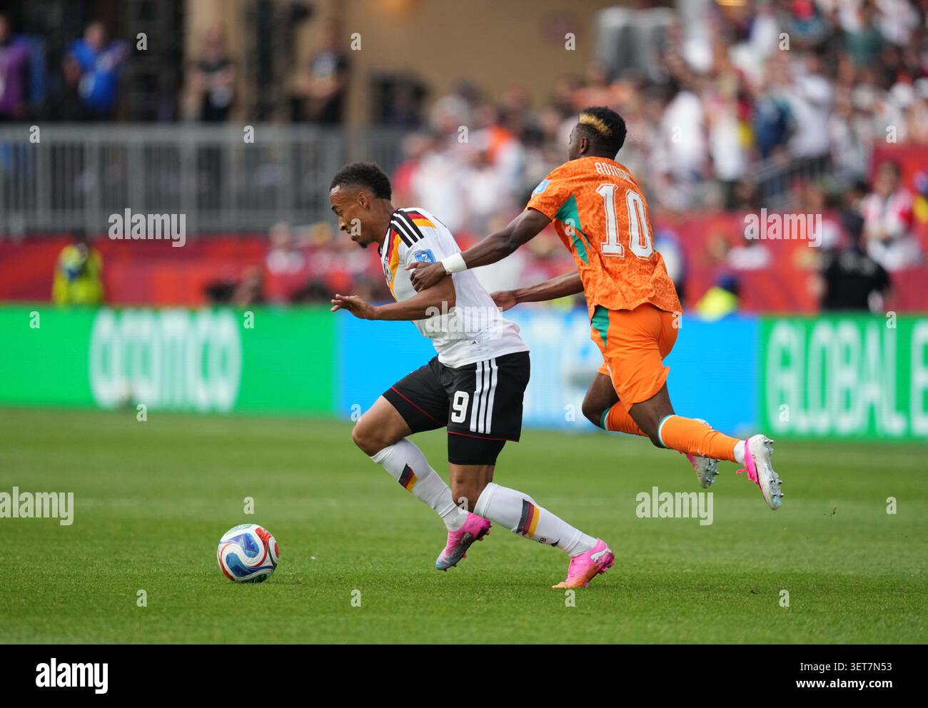 Jamie Leweling (Germany) and Simon Adingra (Ivory Coast) battle for the ...