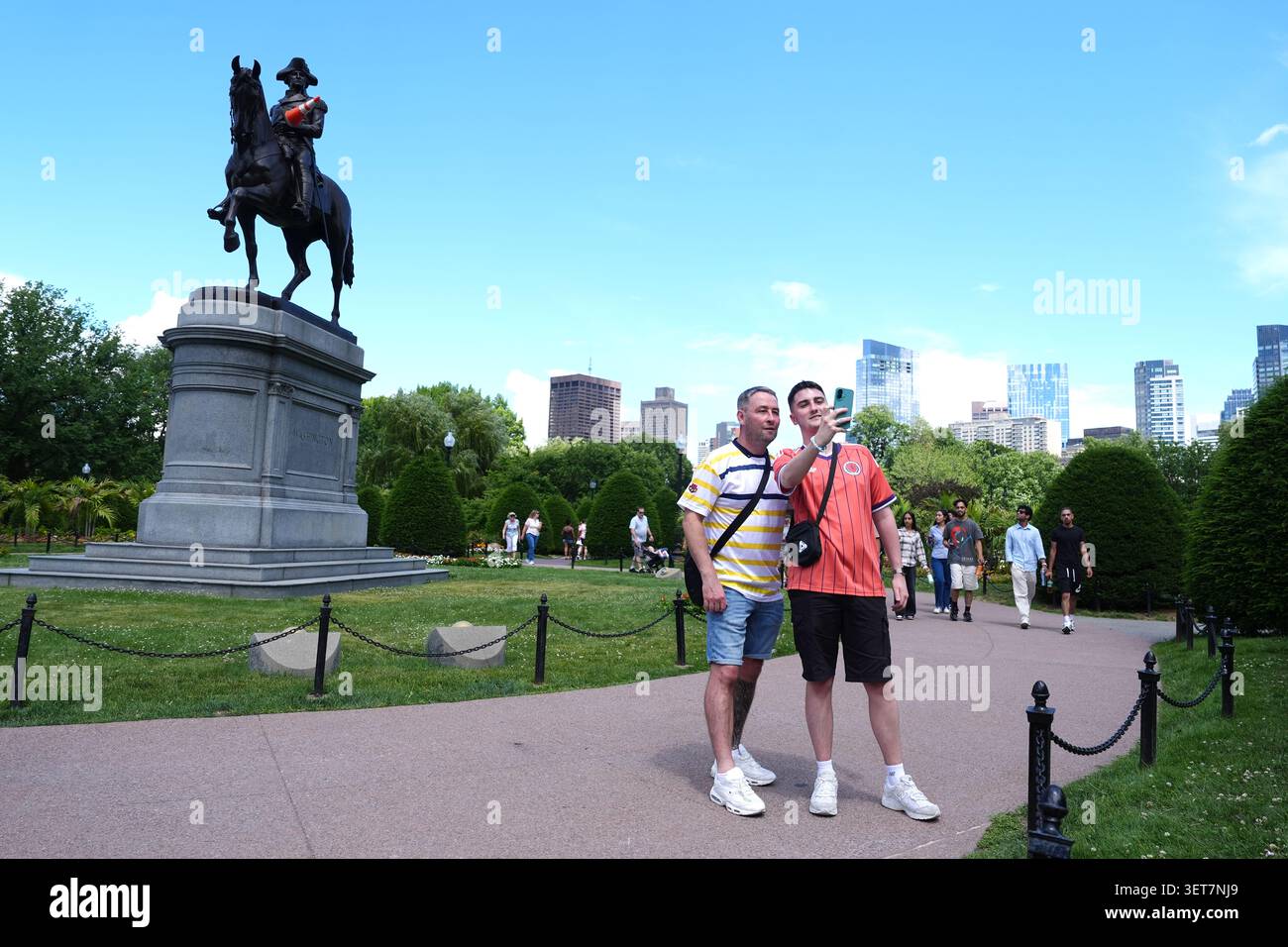 Scotland fans take selfies in front of a statue with a orange cone in ...