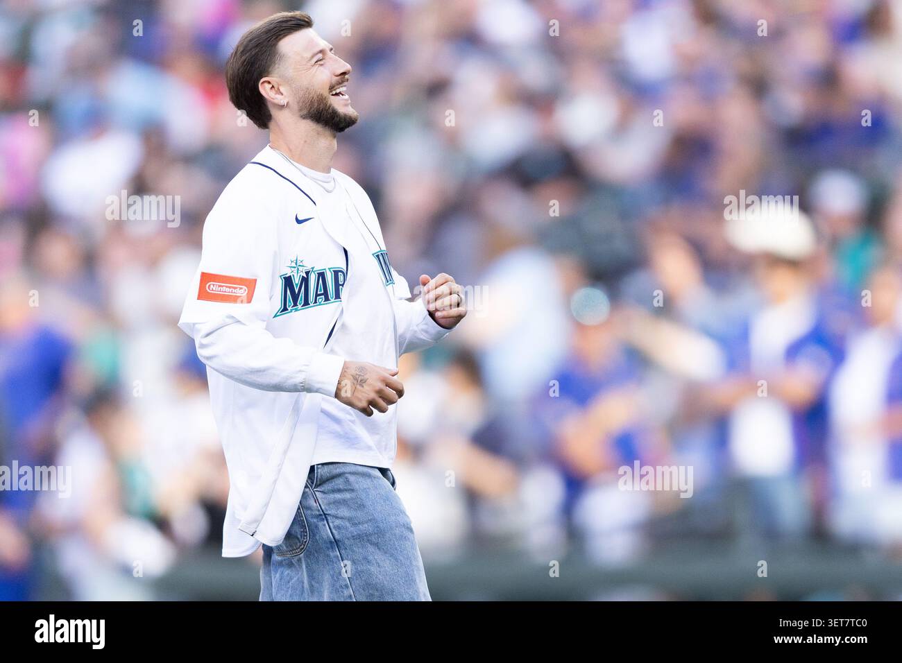 Paul Arriola reacts after throwing the ceremonial first pitch before a ...