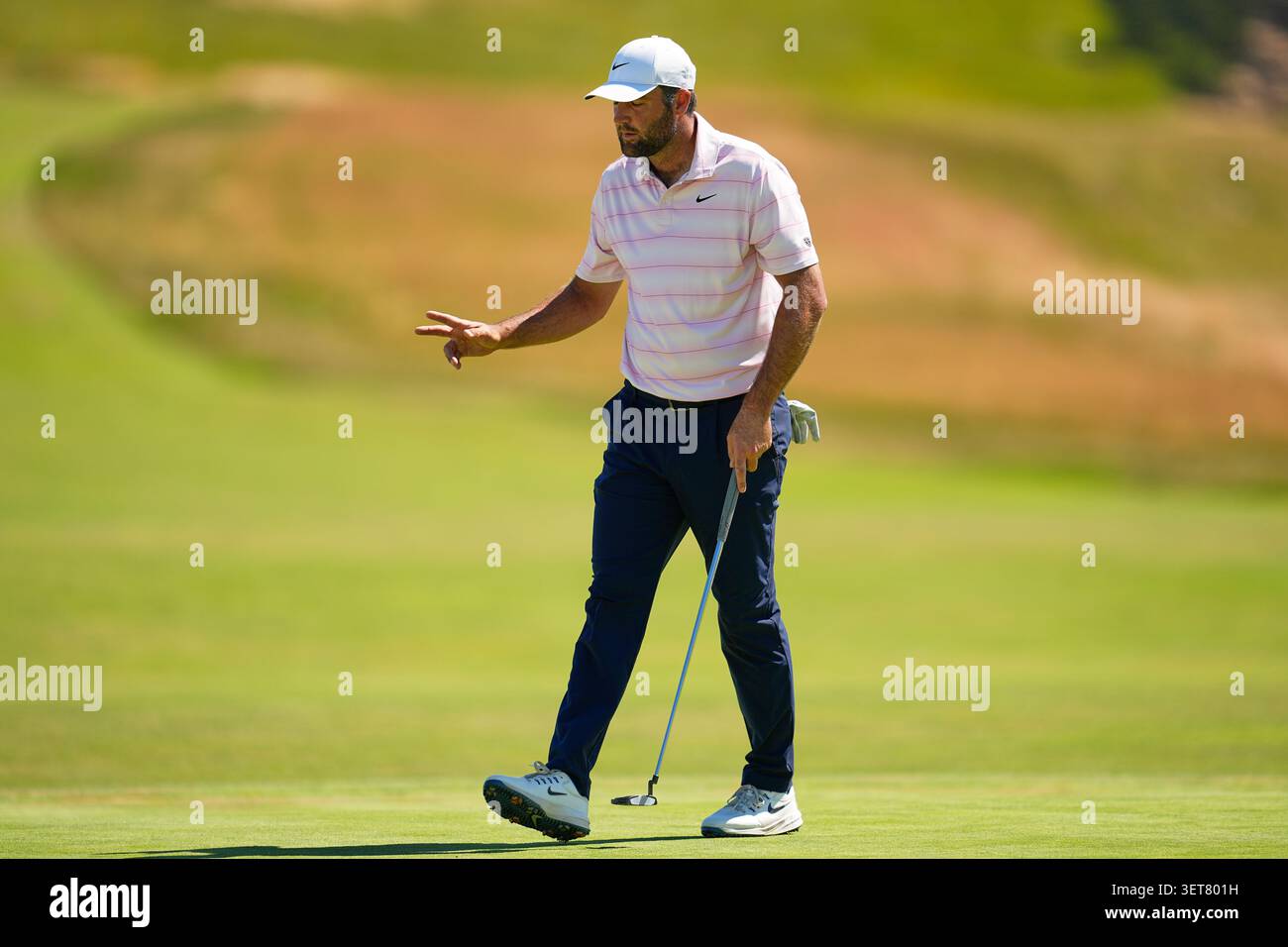 Scottie Scheffler waves after his putt on the third hole during the ...