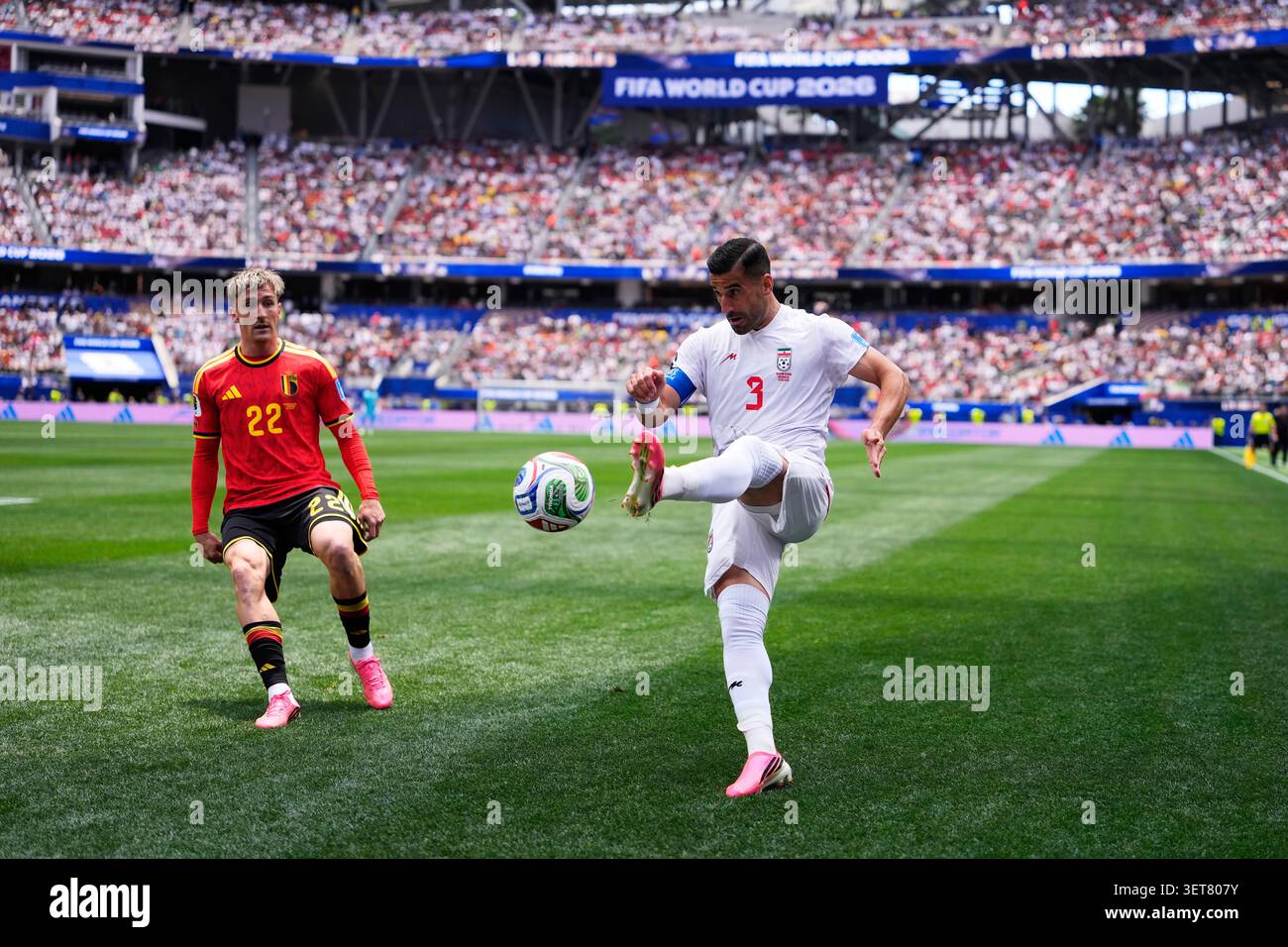 Iran's Ehsan Hajisafi kicks the ball as Belgium's Alexis Saelemaekers ...