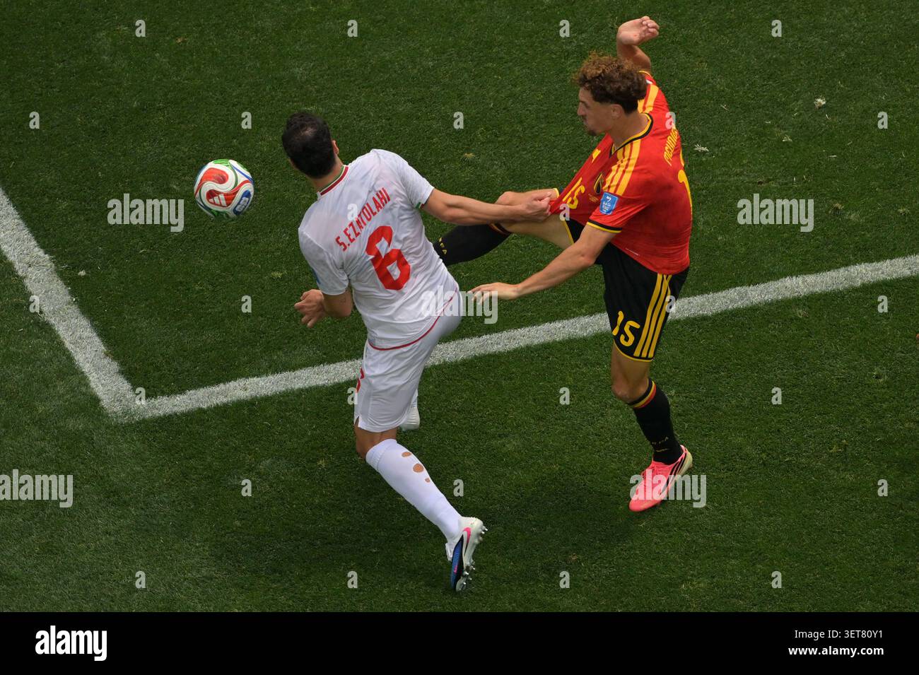 Iran's Saeid Ezatolahi (6) and Belgium's Thomas Meunier (15) fight for ...