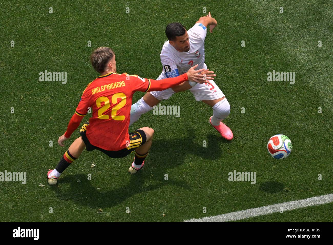 Belgium's Alexis Saelemaekers (22) and Iran's Ehsan Hajisafi (3) fight ...