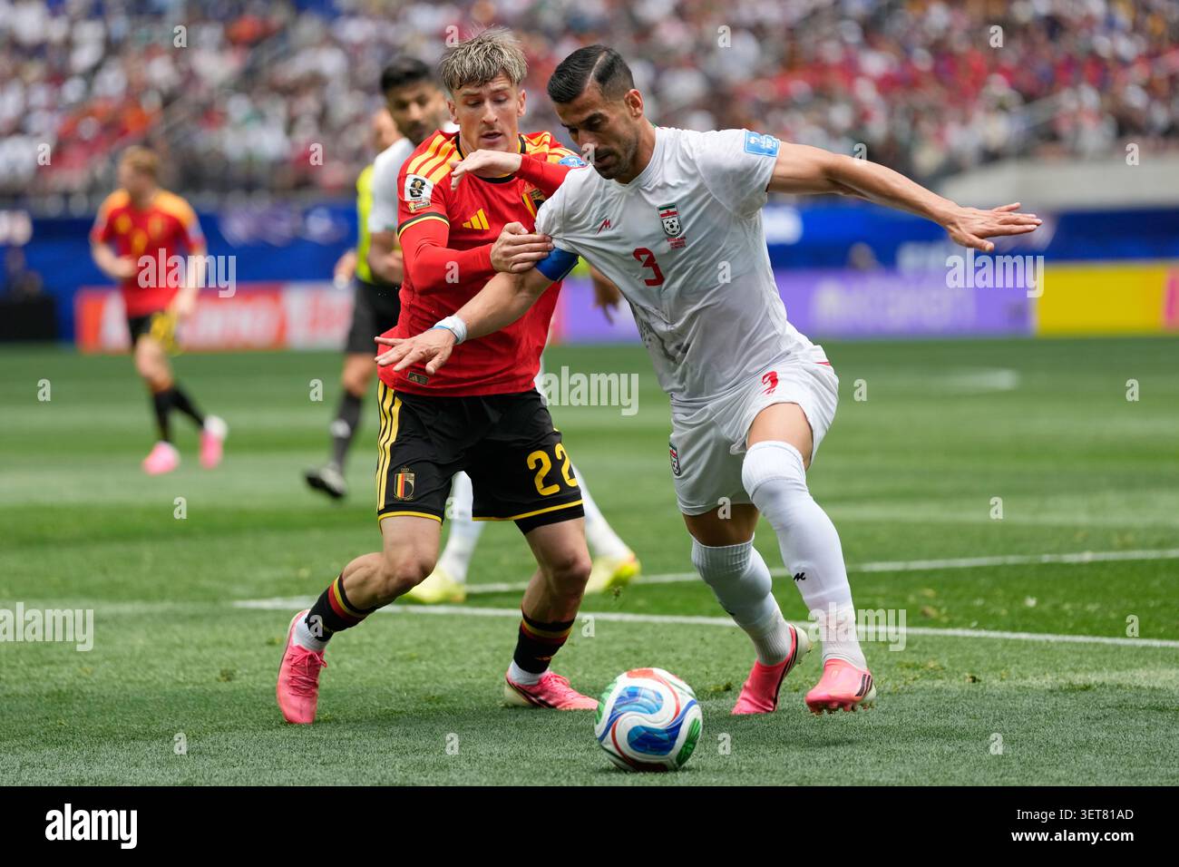 Belgium's Alexis Saelemaekers, left, challenges Iran's Ehsan Hajisafi ...