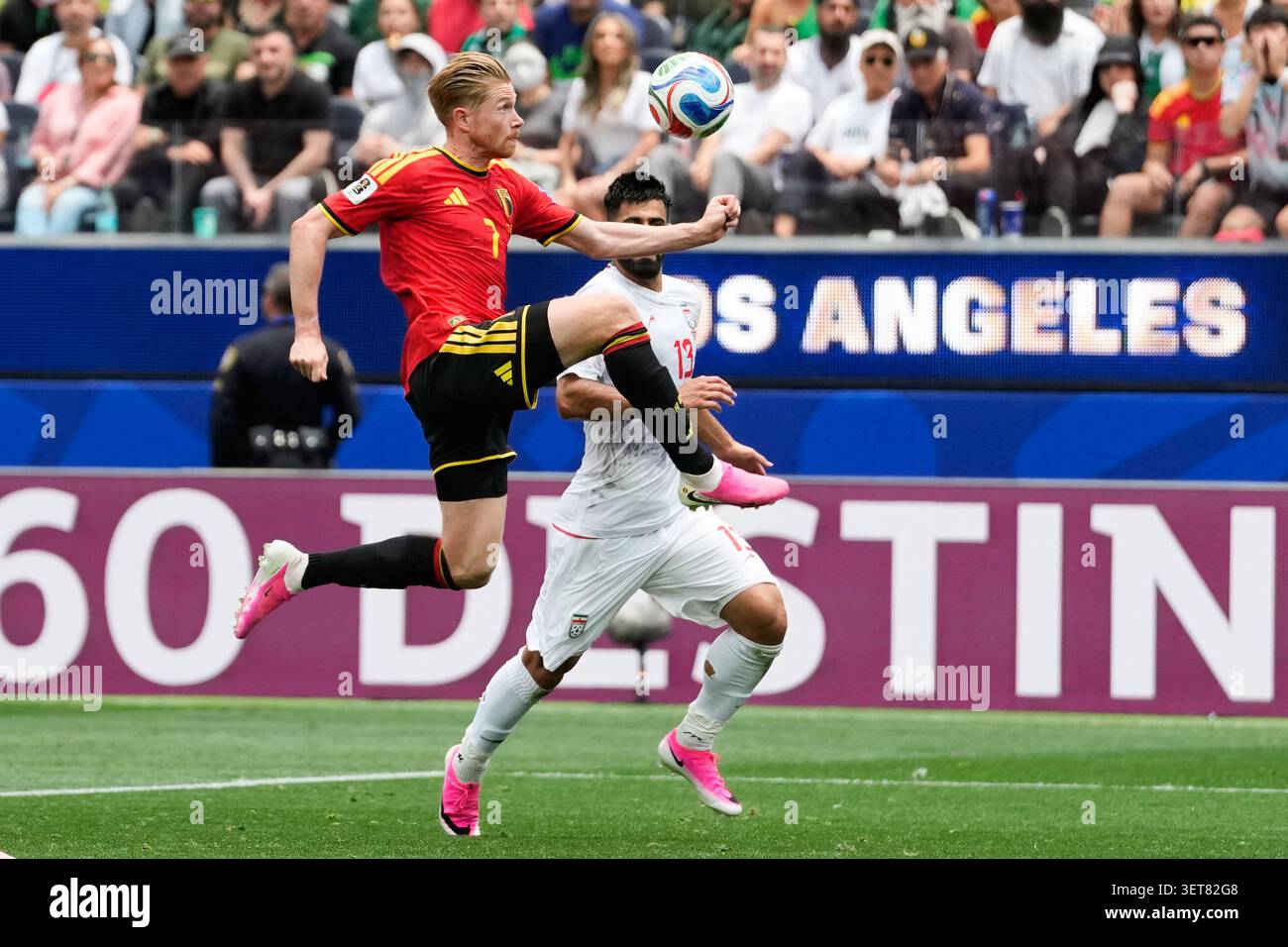 Belgium's Kevin De Bruyne, front, tries control the ball past Iran's ...