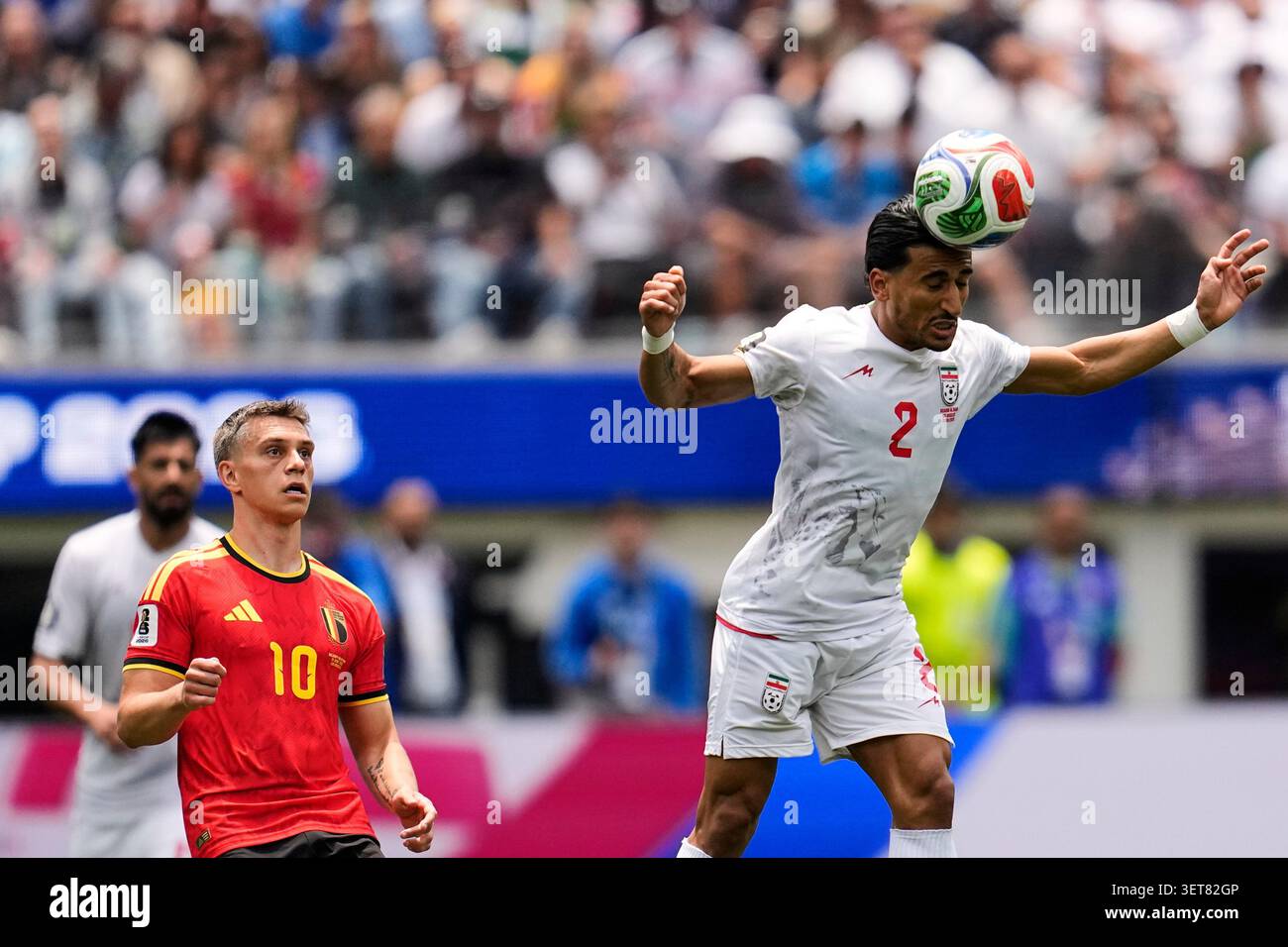 Iran's Saleh Hardani (2), right, heads for the ball next to Belgium's ...