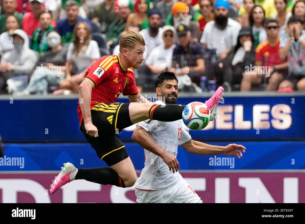 Belgium's Kevin De Bruyne, front, tries control the ball past Iran's ...